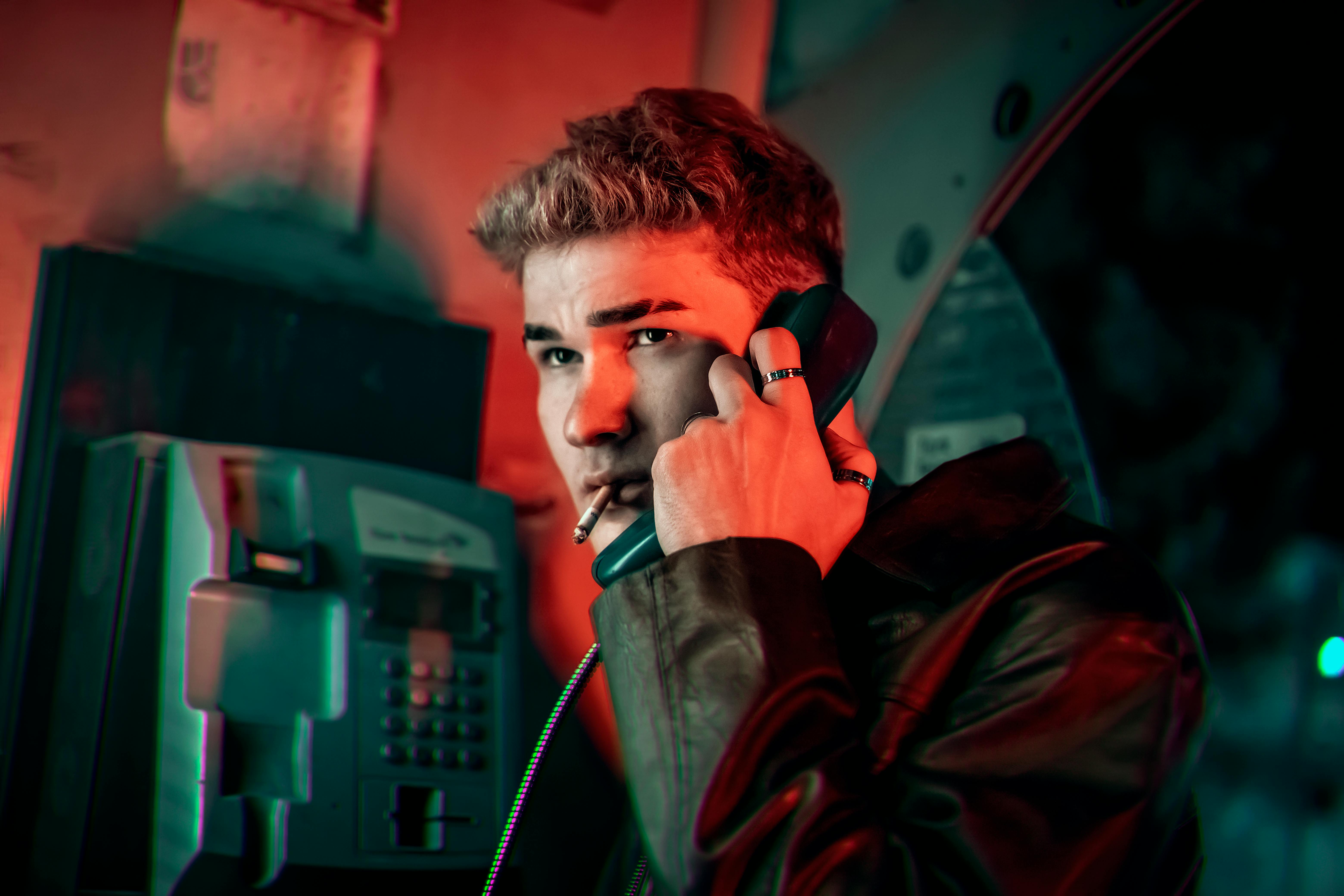 Man Standing Inside a Telephone Booth · Free Stock Photo