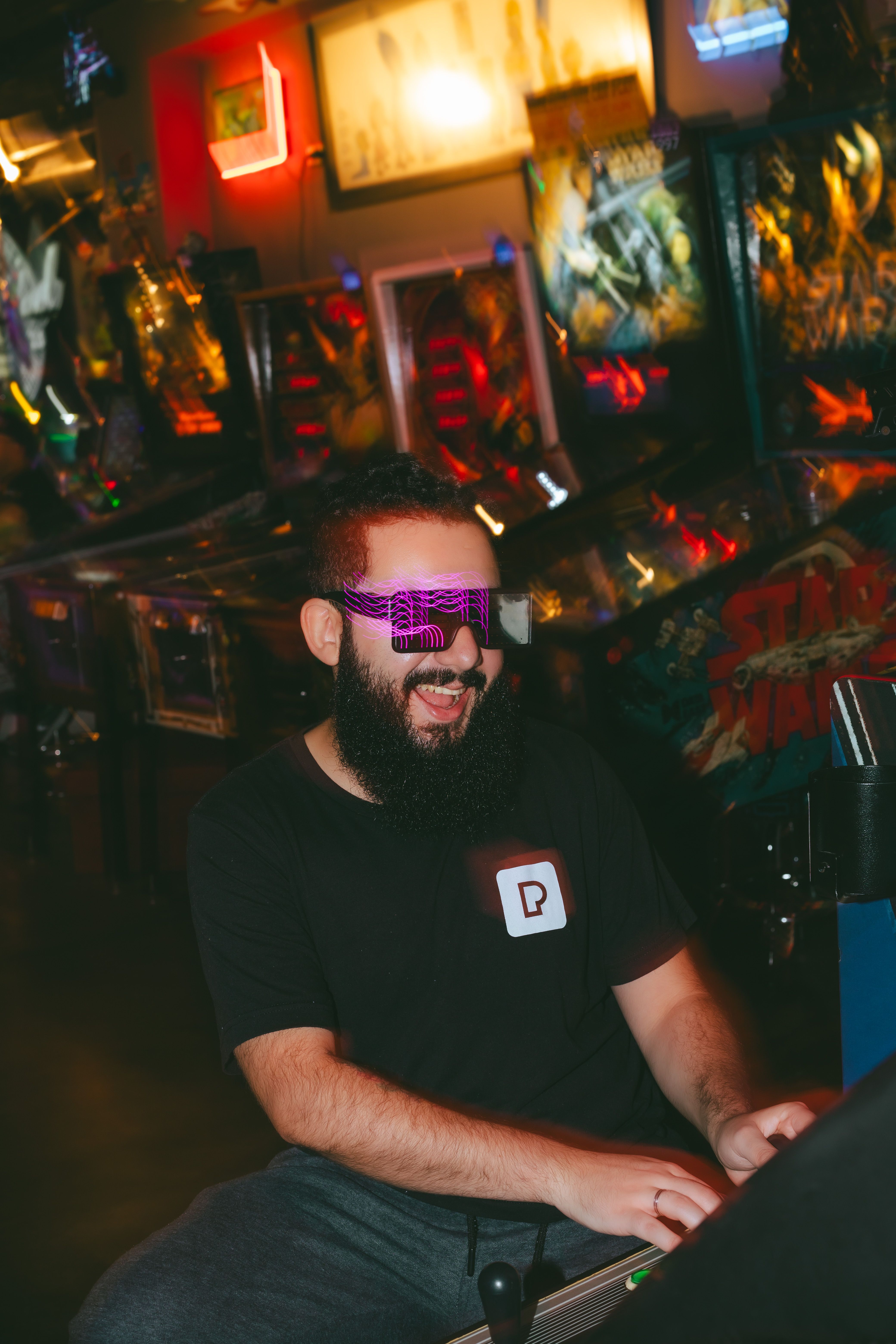 Happy Man Sitting at Arcade Game Machine · Free Stock Photo