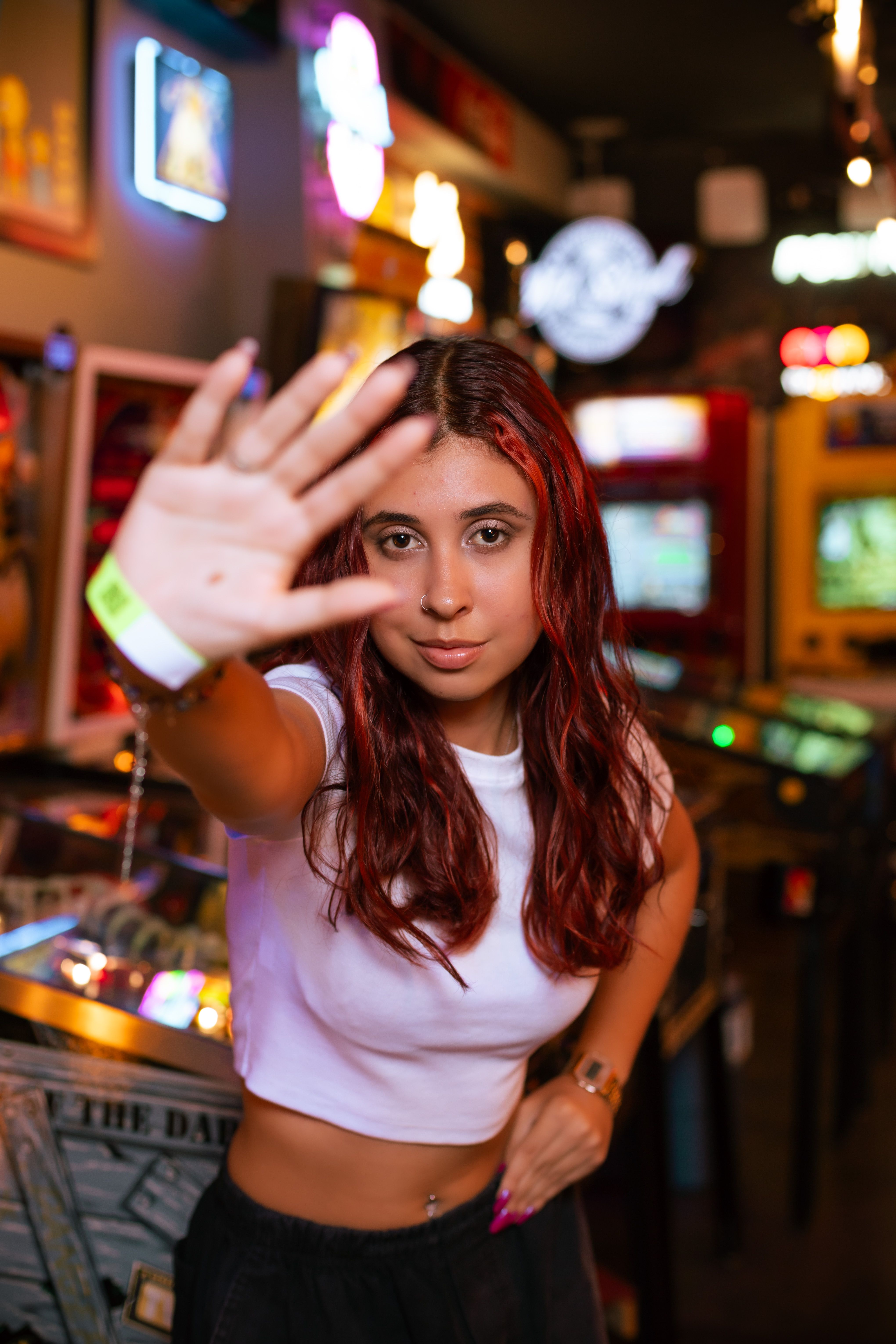 Woman with Dyed Hair Posing with Hand Raised · Free Stock Photo