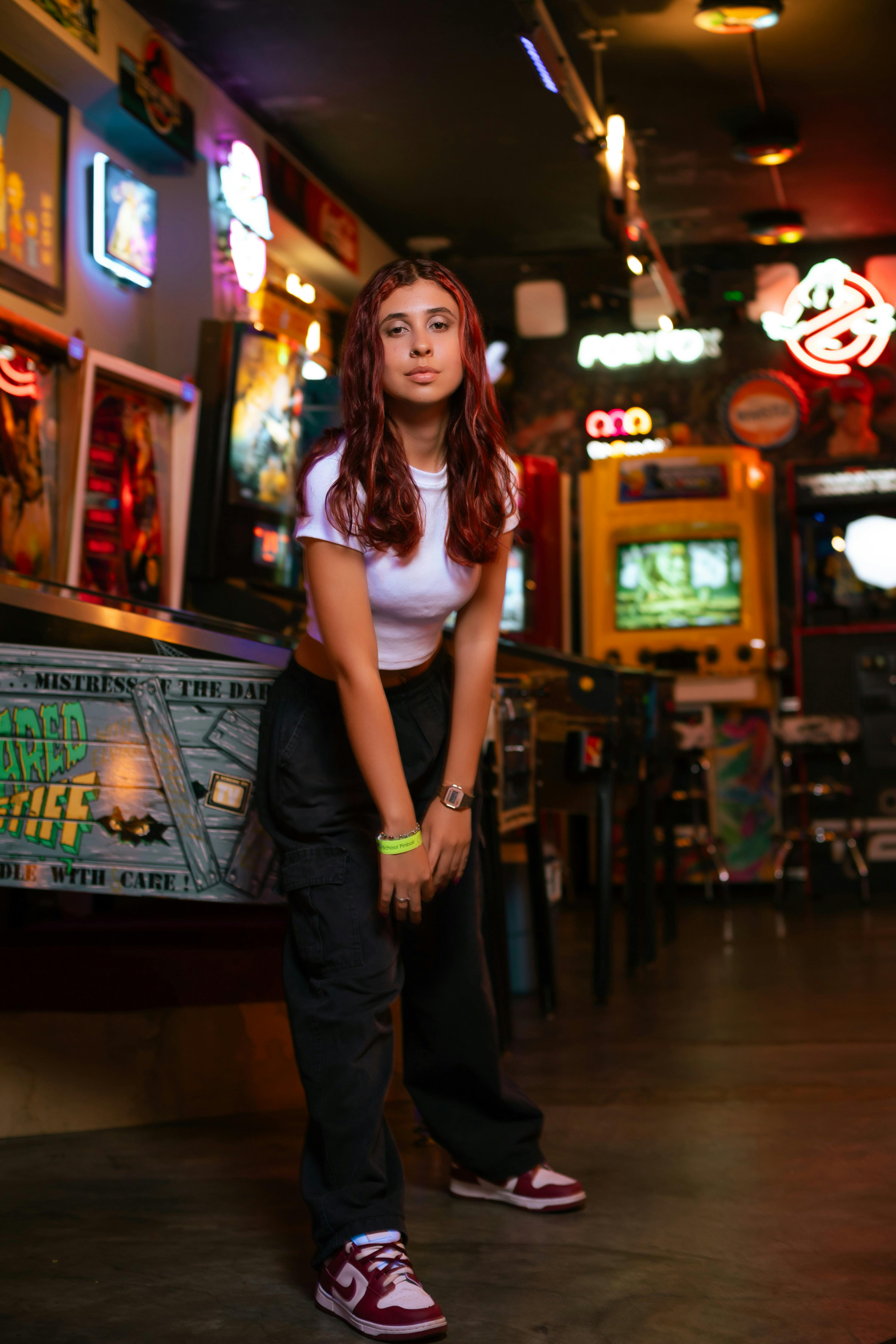 Woman Standing in Arcade Game Room · Free Stock Photo