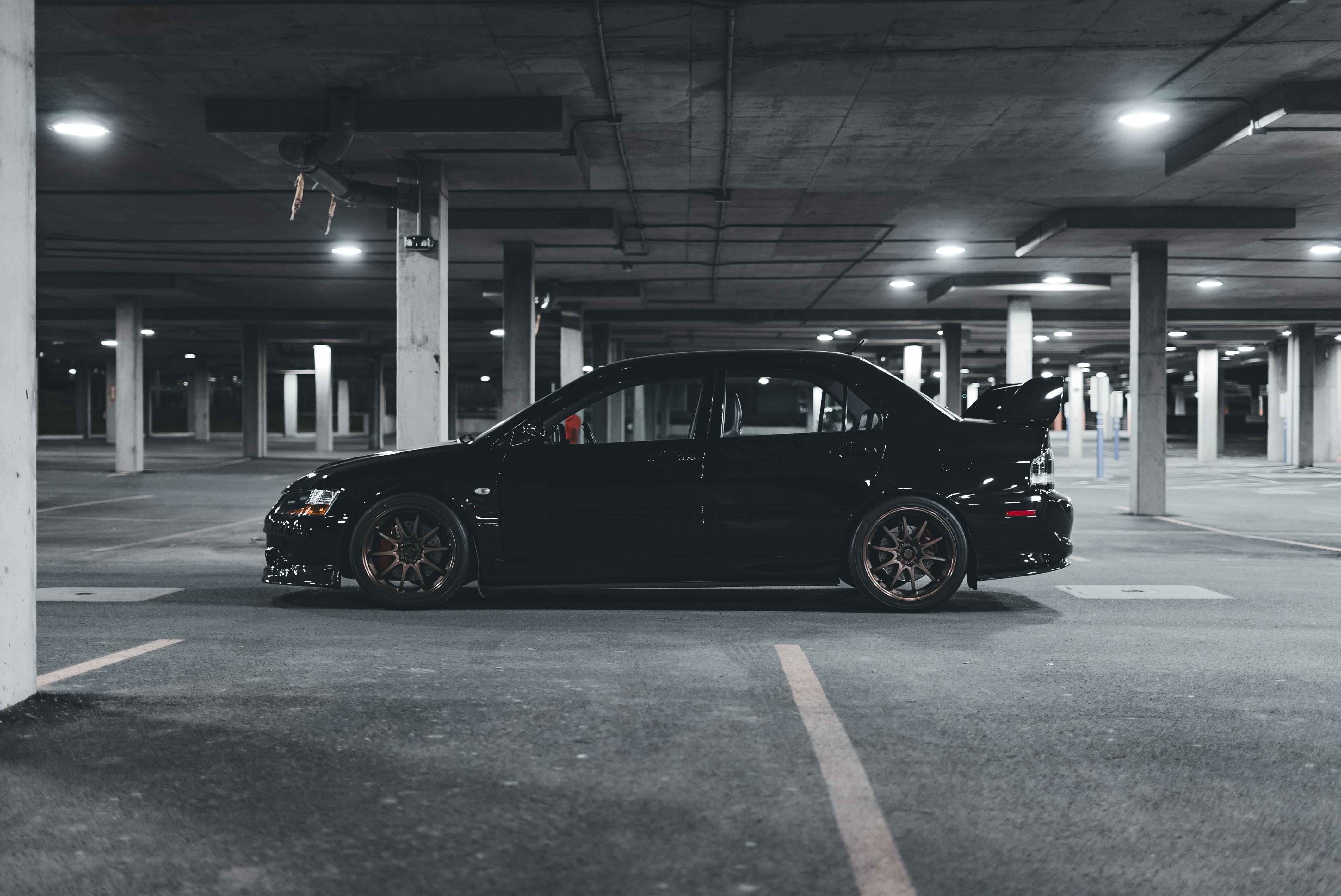 Black Mitsubishi Lancer Evolution on Car Park · Free Stock Photo