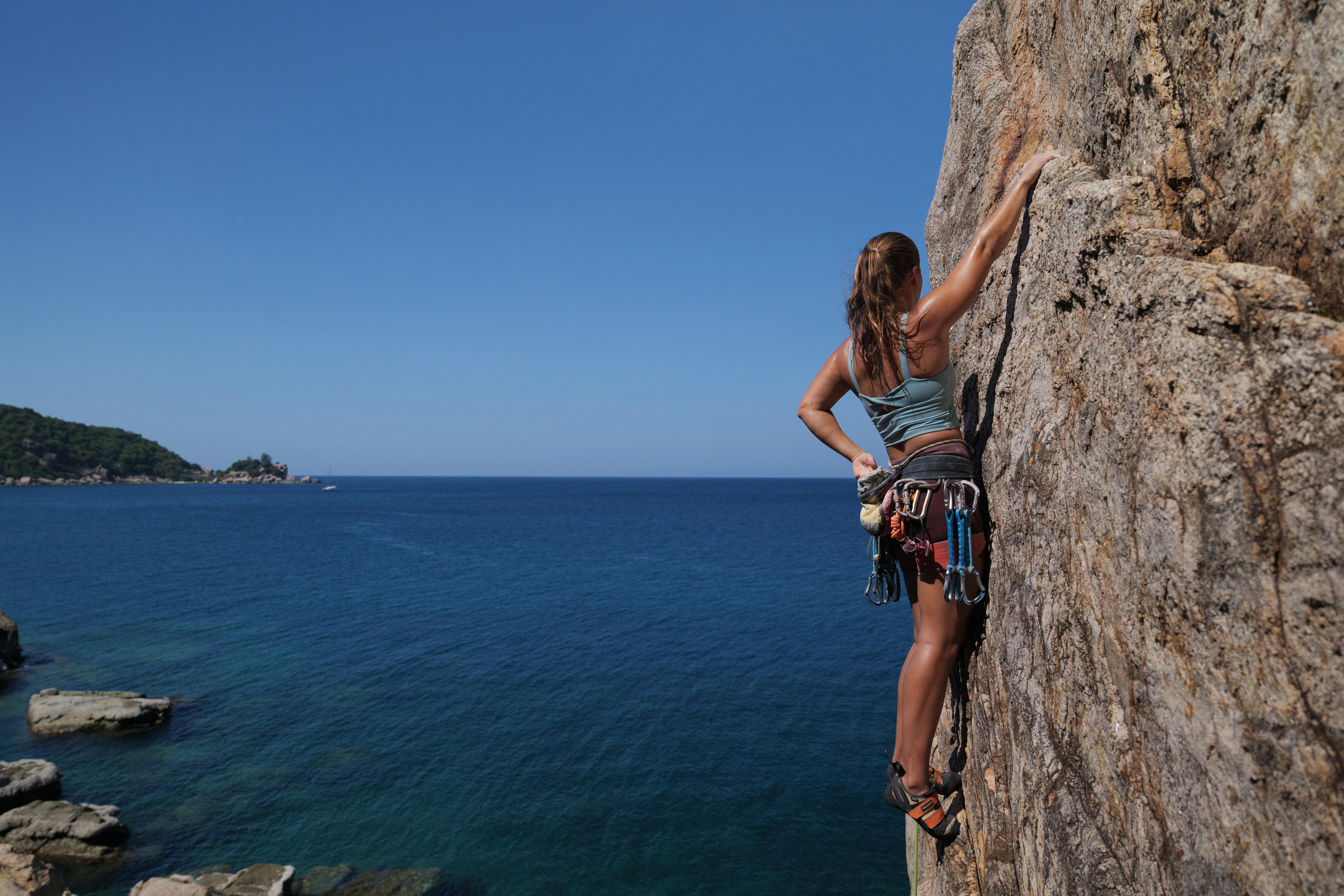 Rock Climbing Woman on Sea Shore · Free Stock Photo