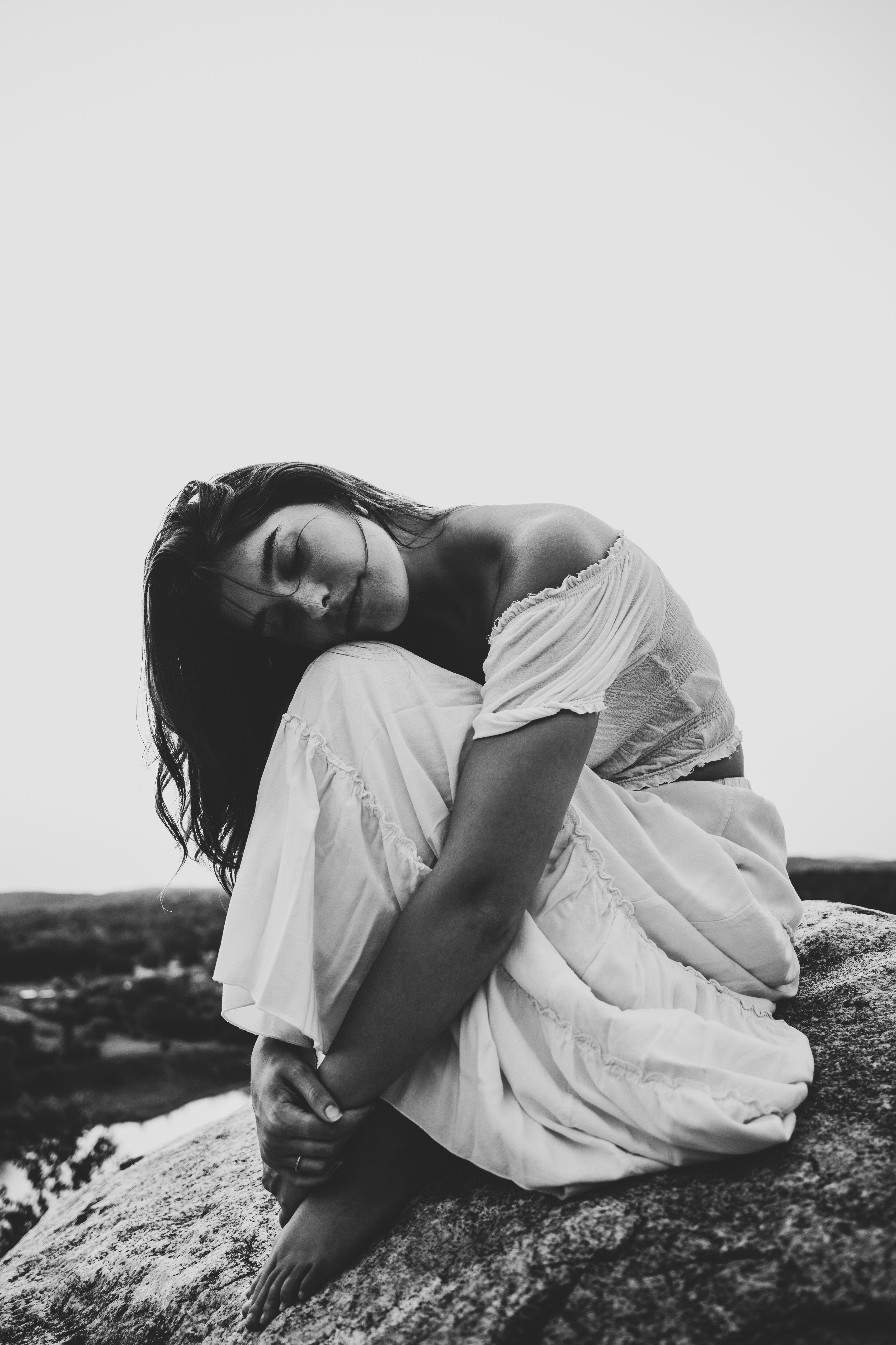 Woman in White Skirt Sitting in Black and White · Free Stock Photo