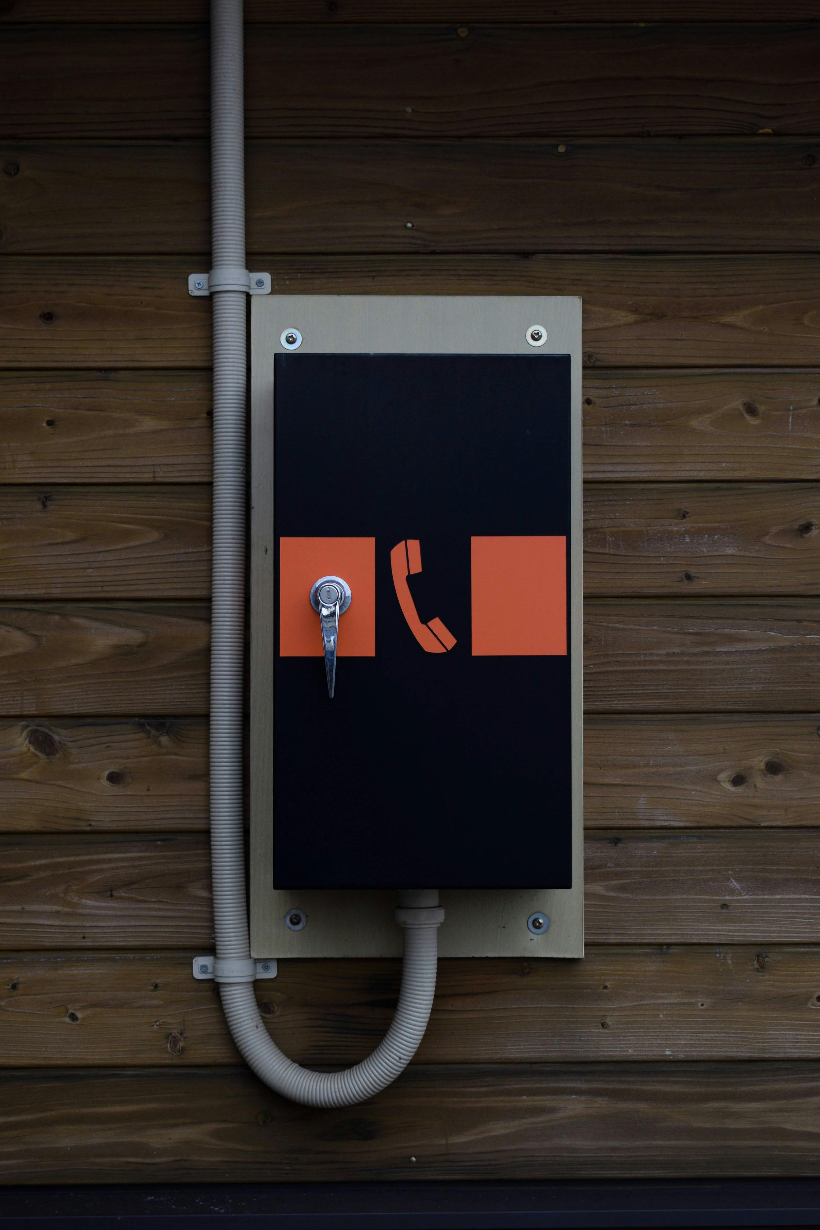 Payphone near shabby wall on street · Free Stock Photo