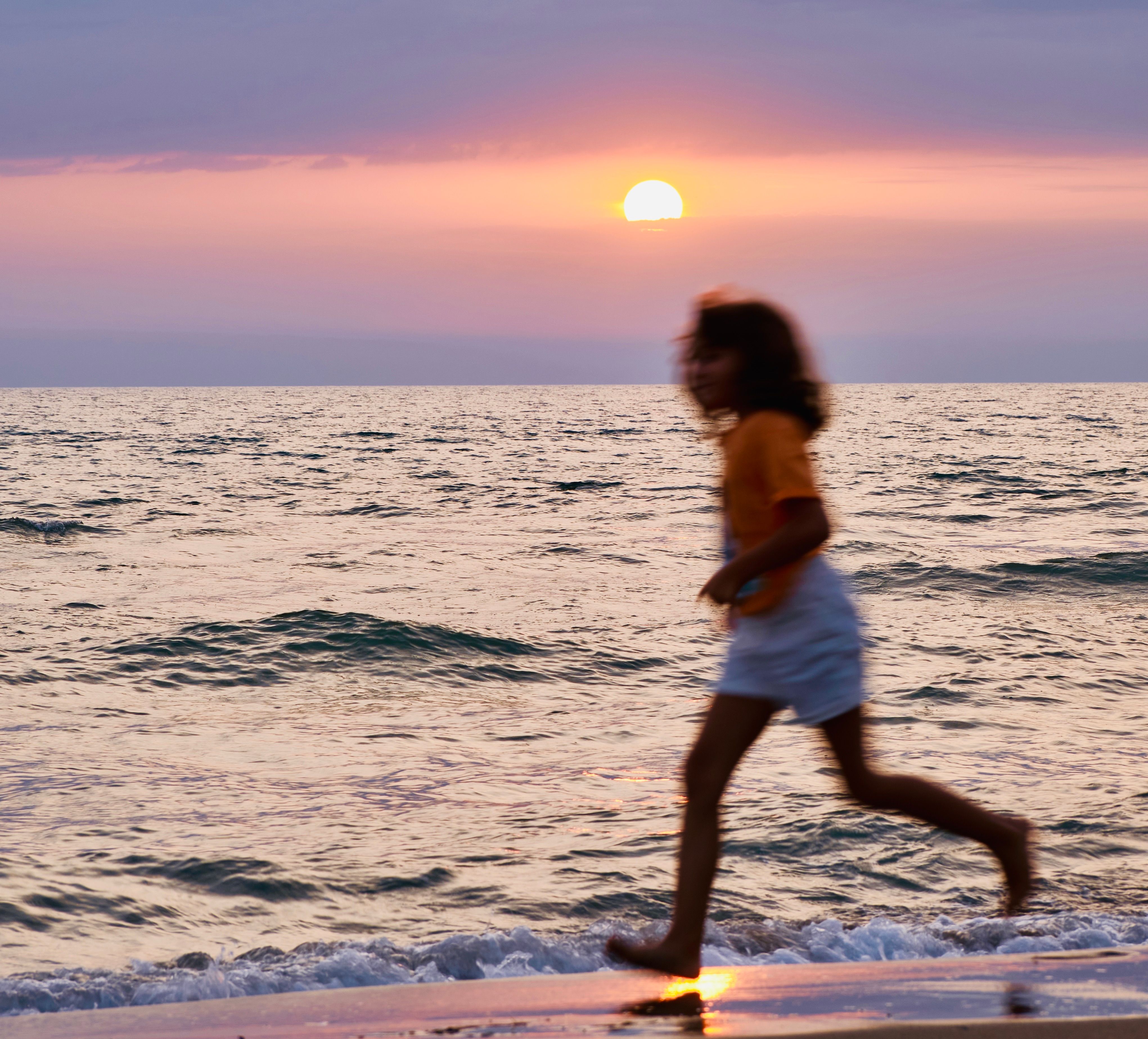 Girl Running along Sea at Dawn · Free Stock Photo