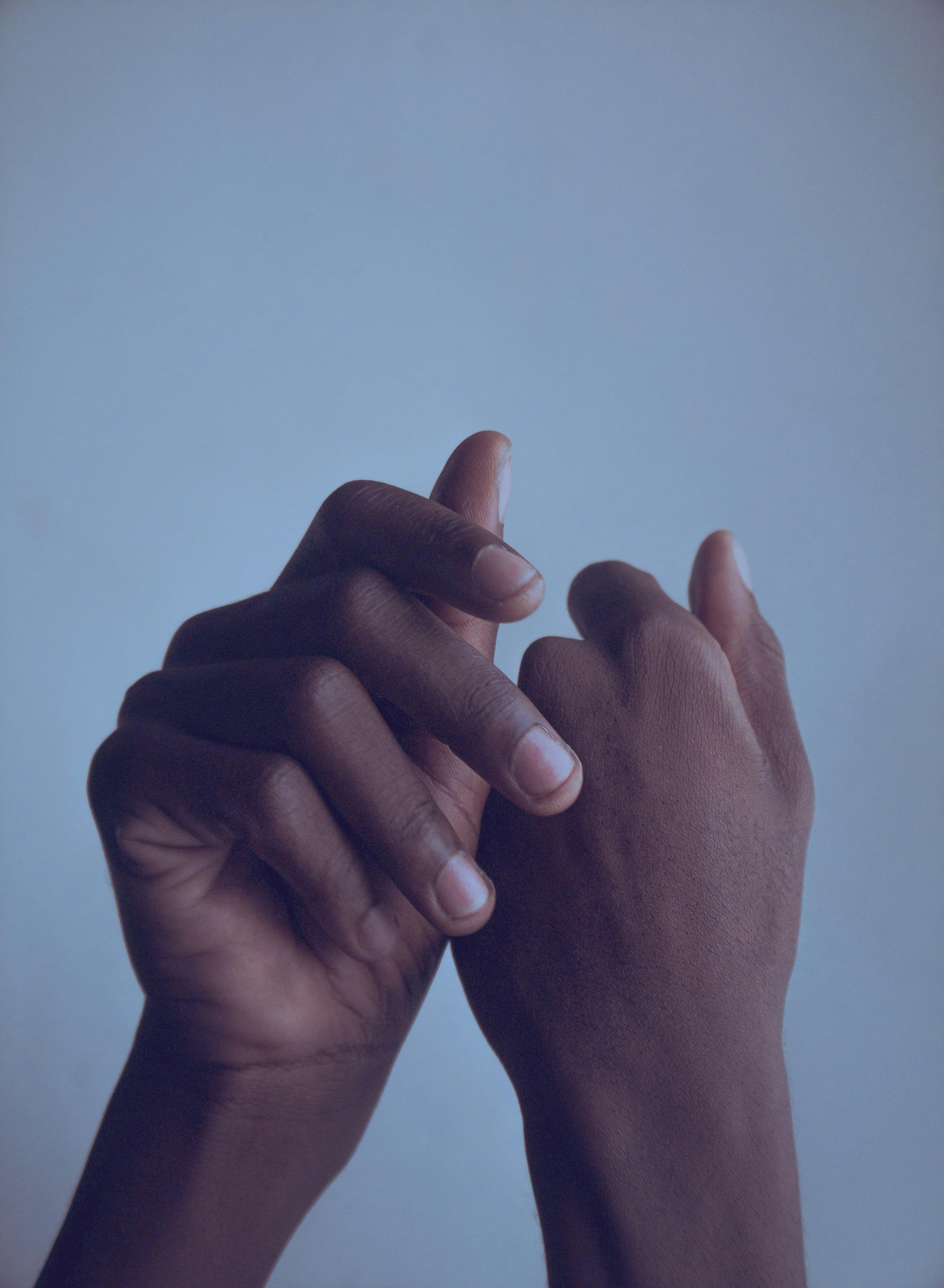 Close-Up Photo of a Person's Hand Touching Body of Water · Free Stock Photo