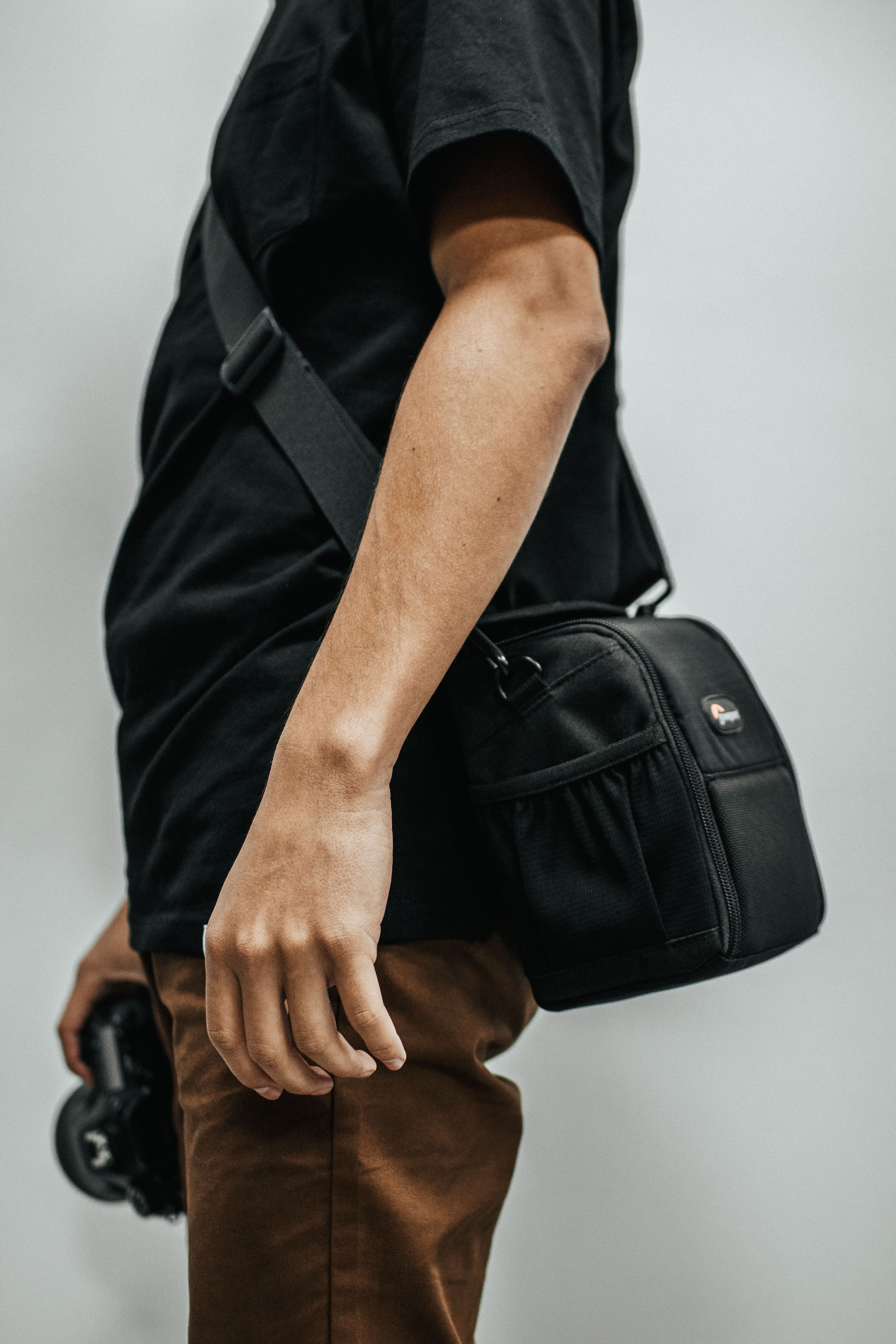Man Holding Camera While Standing · Free Stock Photo