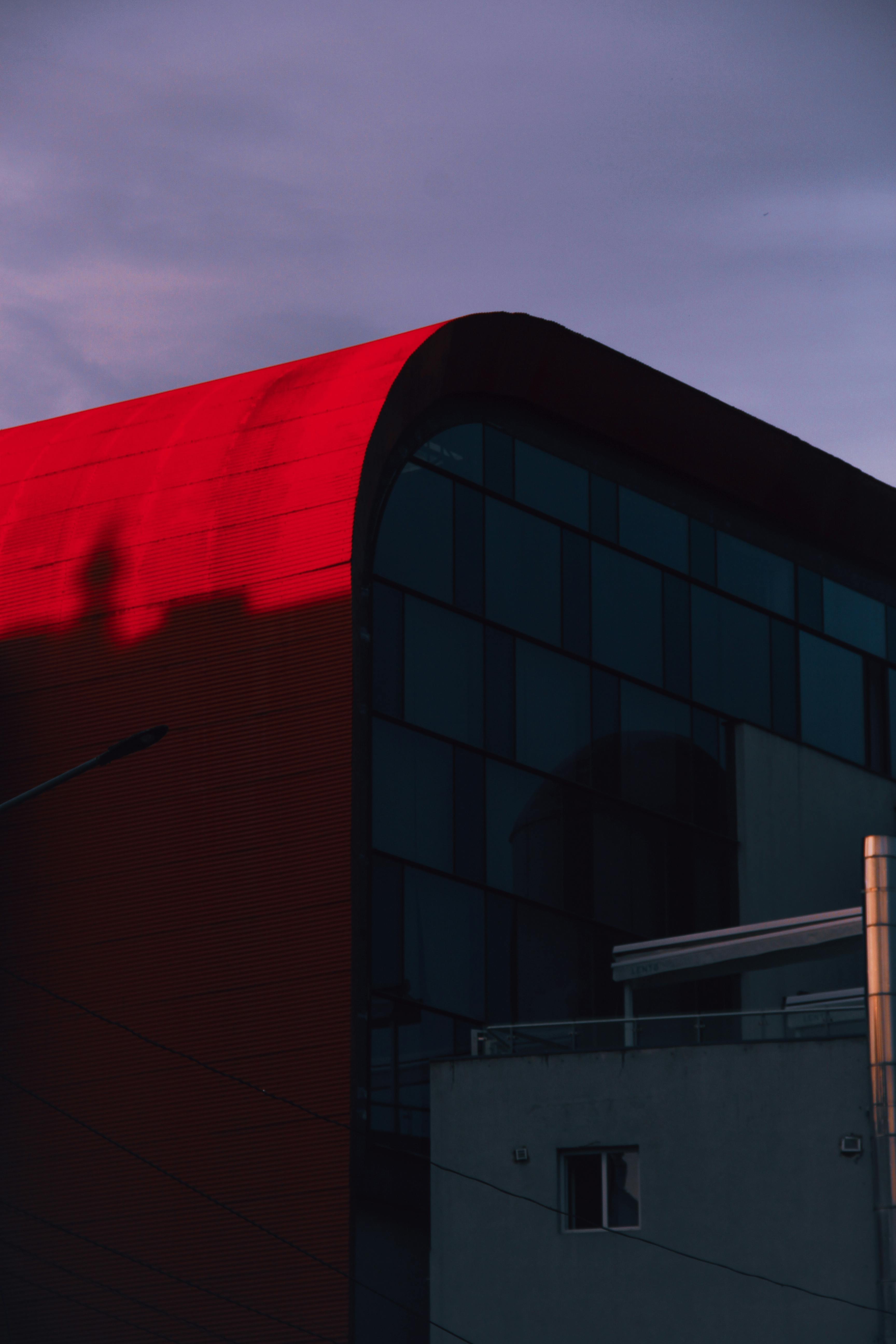 Low Angle Photo of a Red Textured Building Exterior · Free Stock Photo
