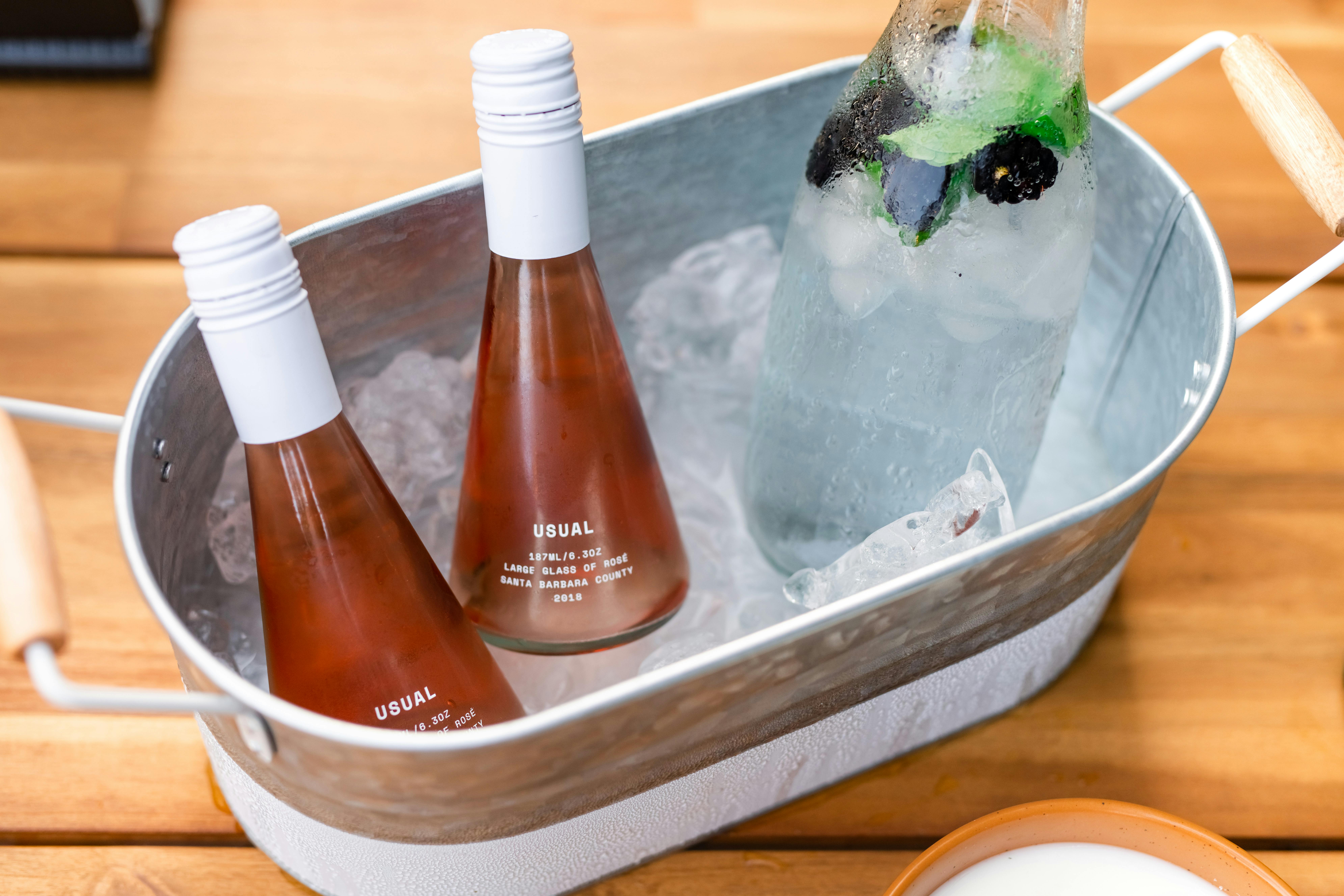 Bottles with Drinks in Bucket with Ice · Free Stock Photo