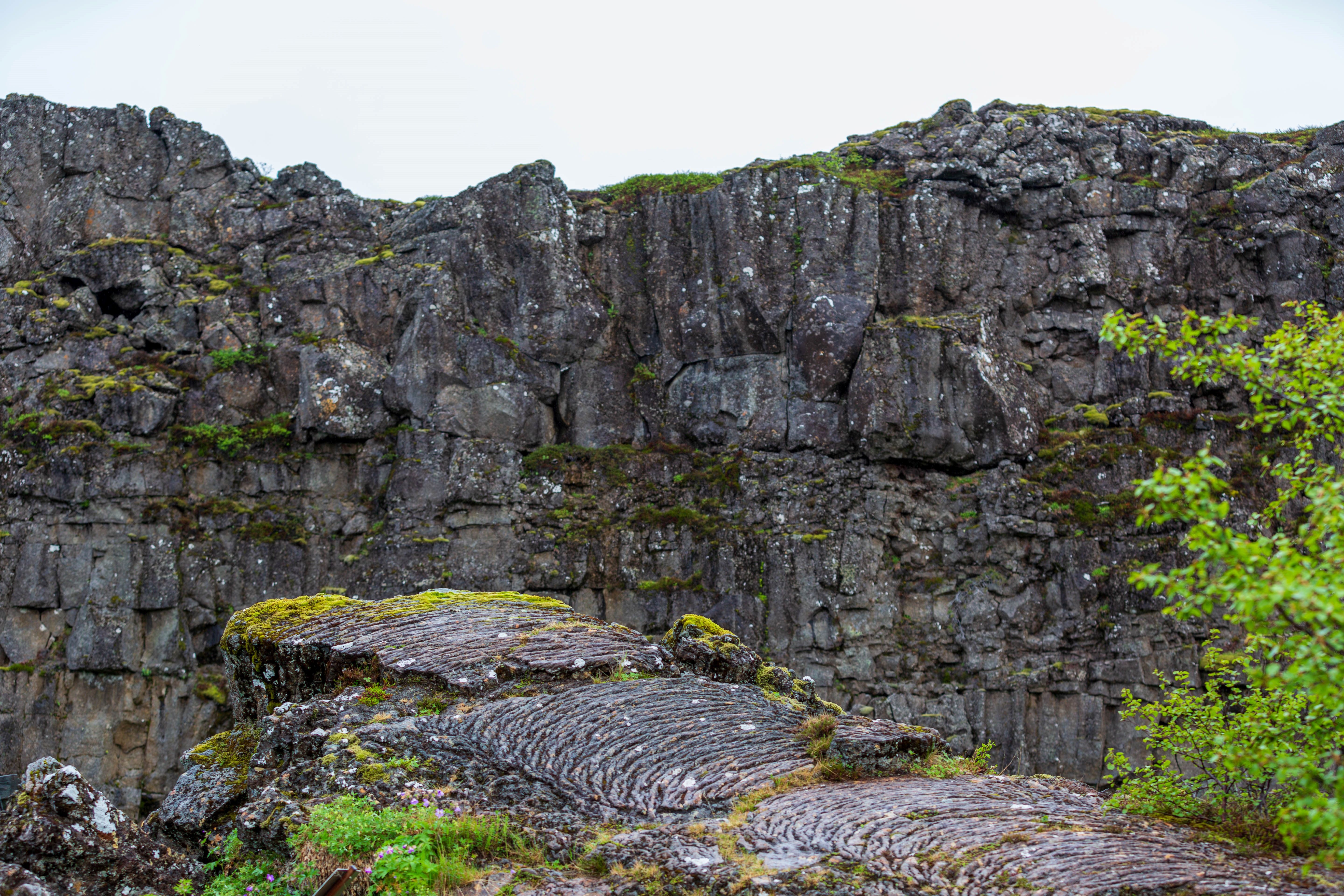 Volcanic Rocks atop Mountain with View of Cliff Face · Free Stock Photo