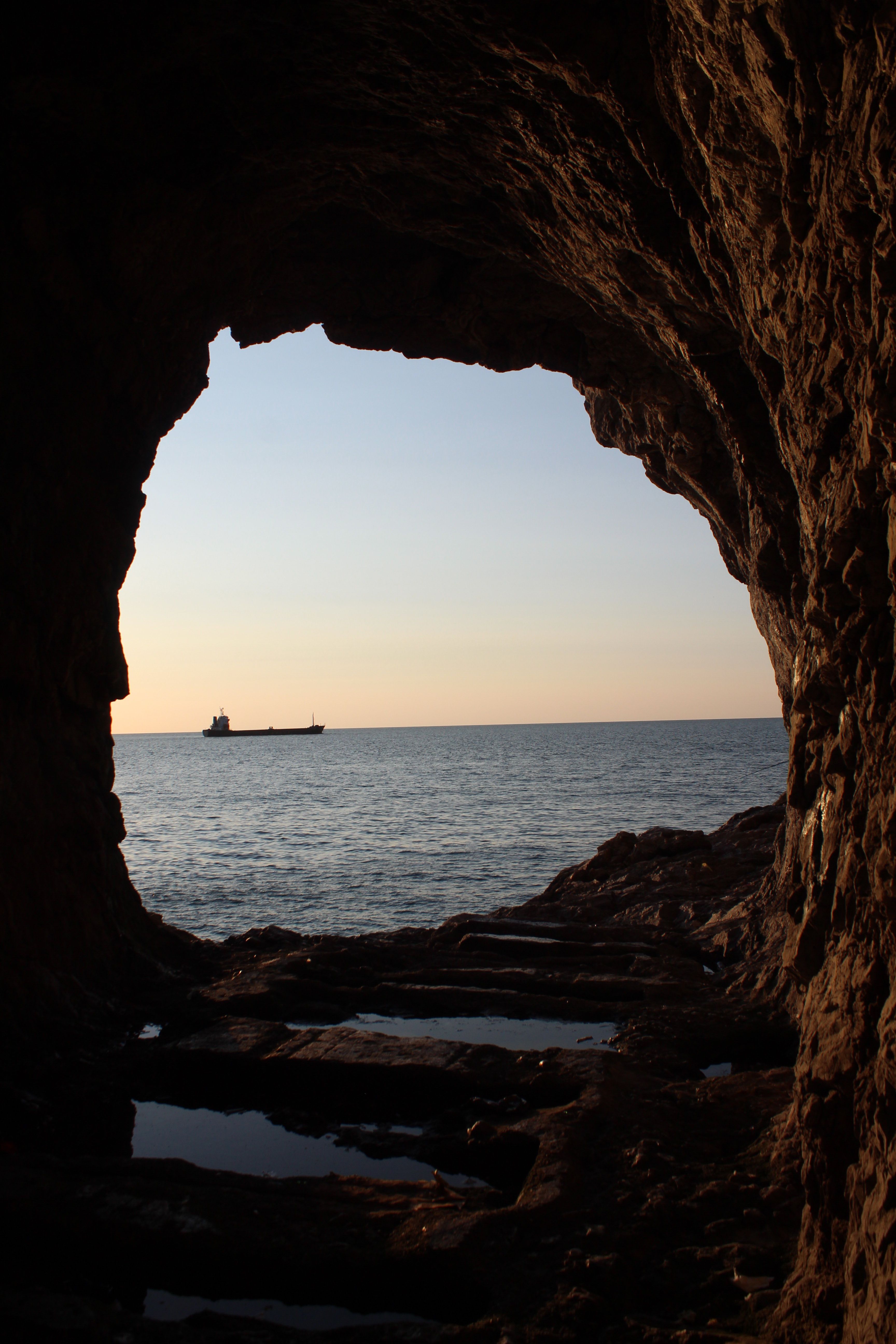 Sea Shore at Sunset behind Cave Entrance · Free Stock Photo