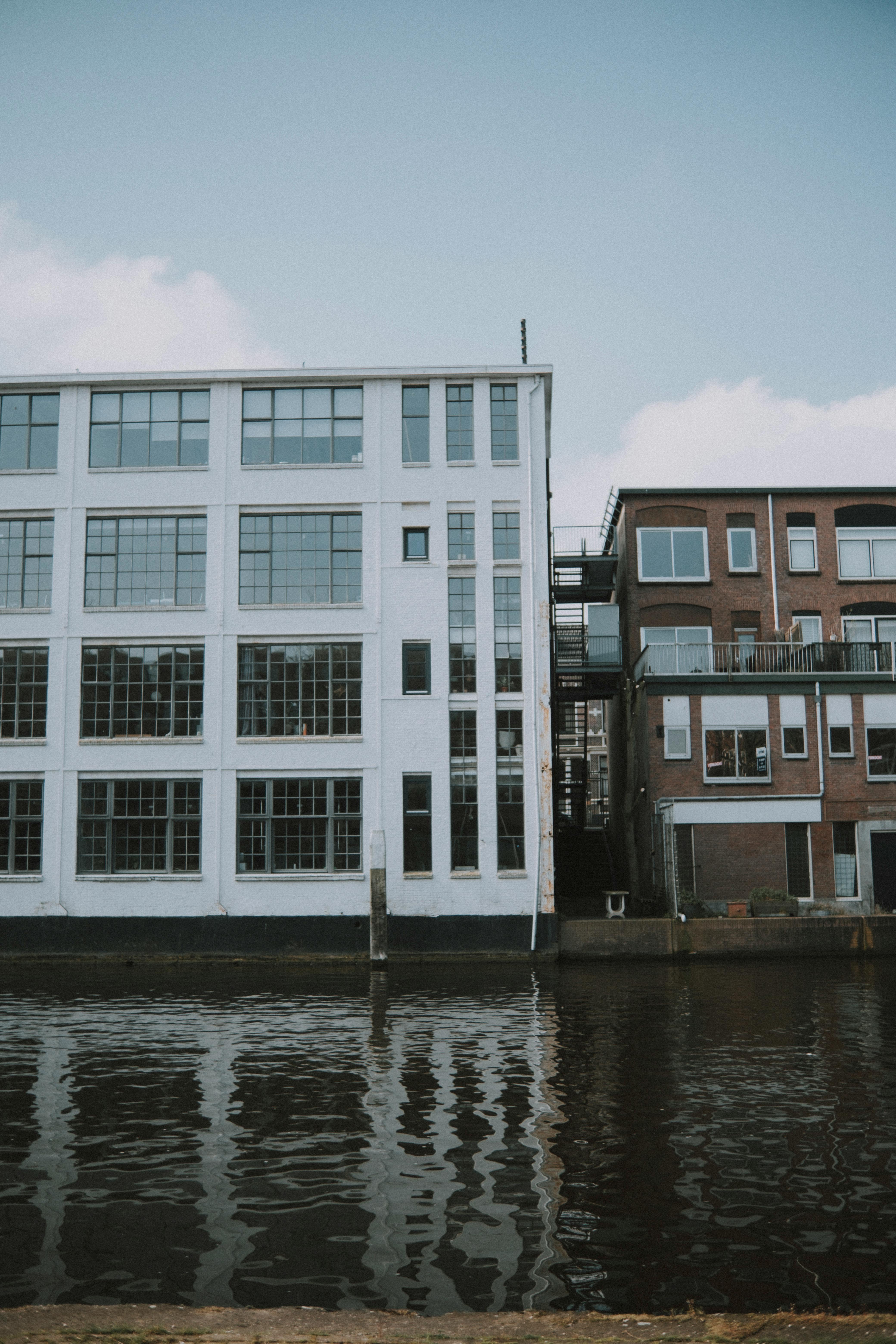 Waterfront View of Factory and Residential Buildings · Free Stock Photo