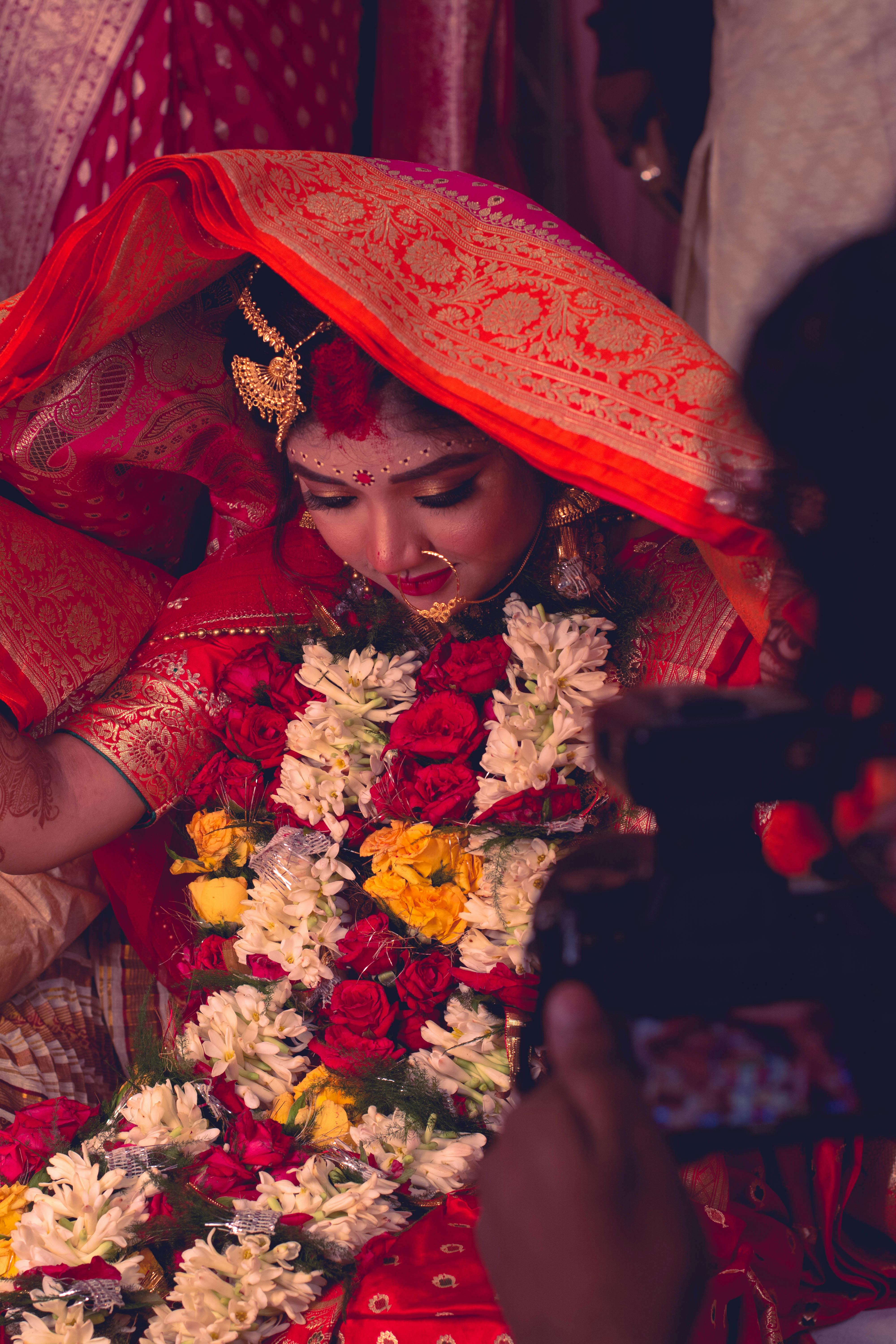 Woman in Traditional Clothing with Flowers Garlands · Free Stock Photo