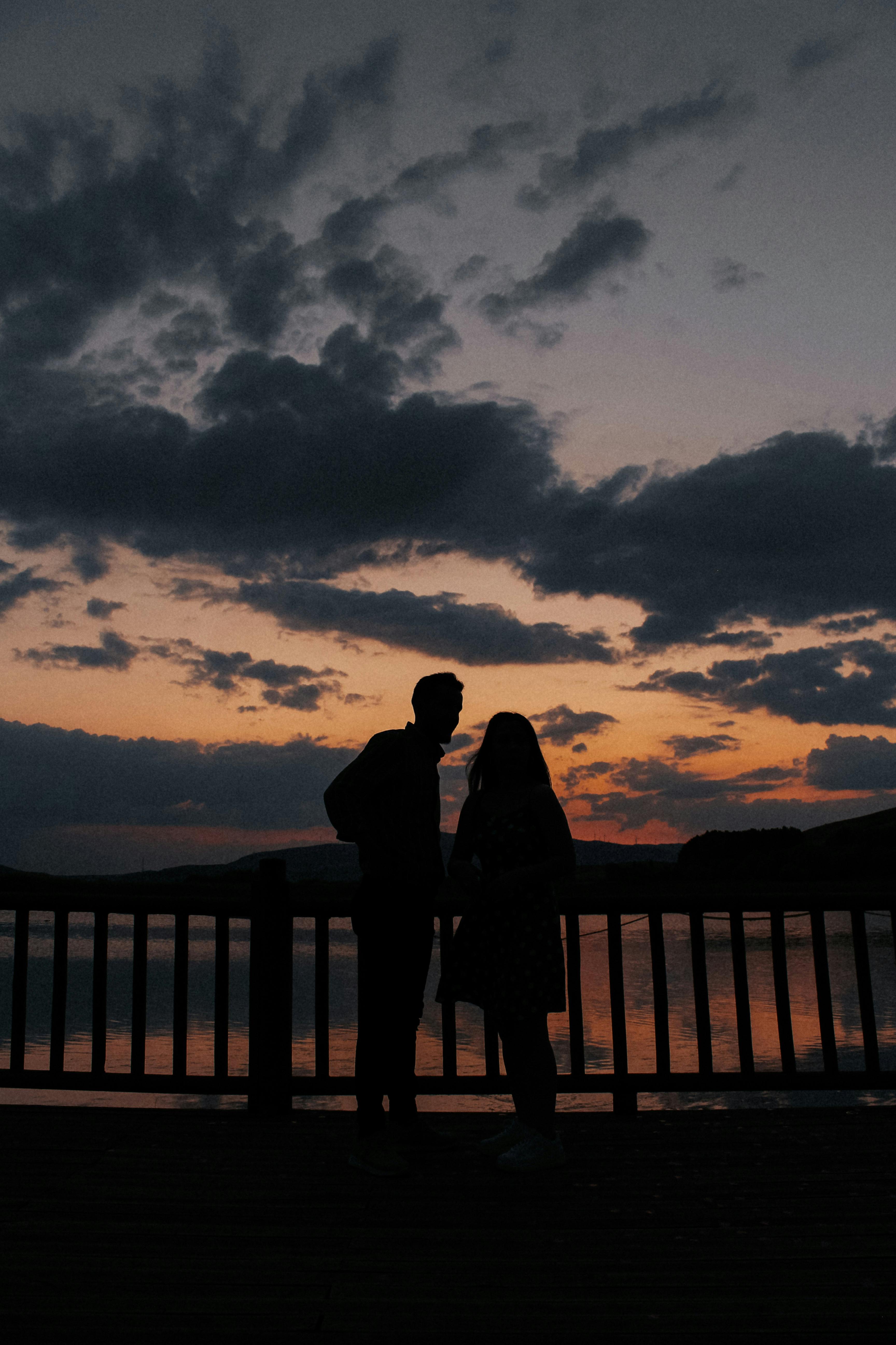 Woman and Man Standing Together under Flag on Shore · Free Stock Photo