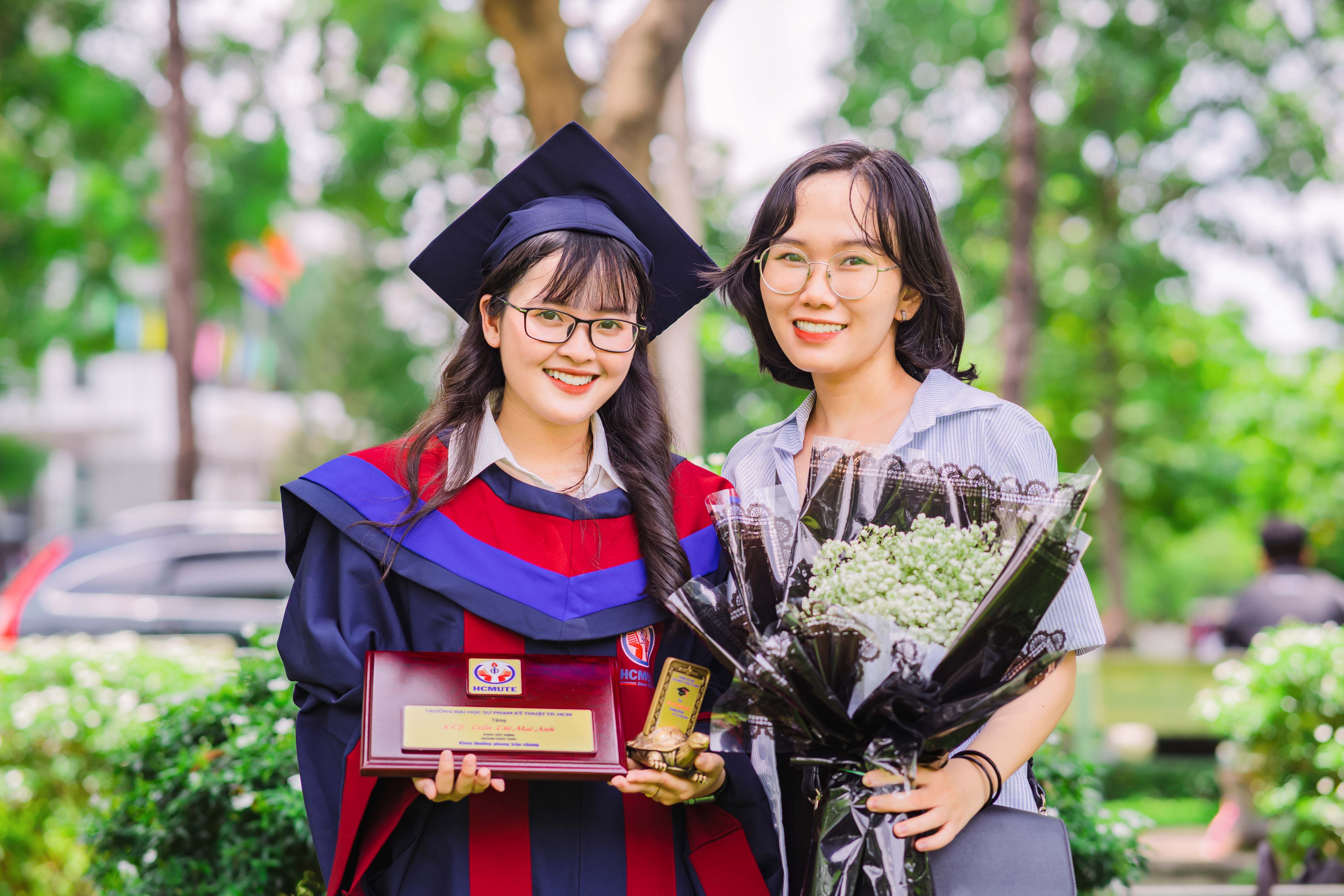 Graduate Student Smiling Beside her Friend · Free Stock Photo