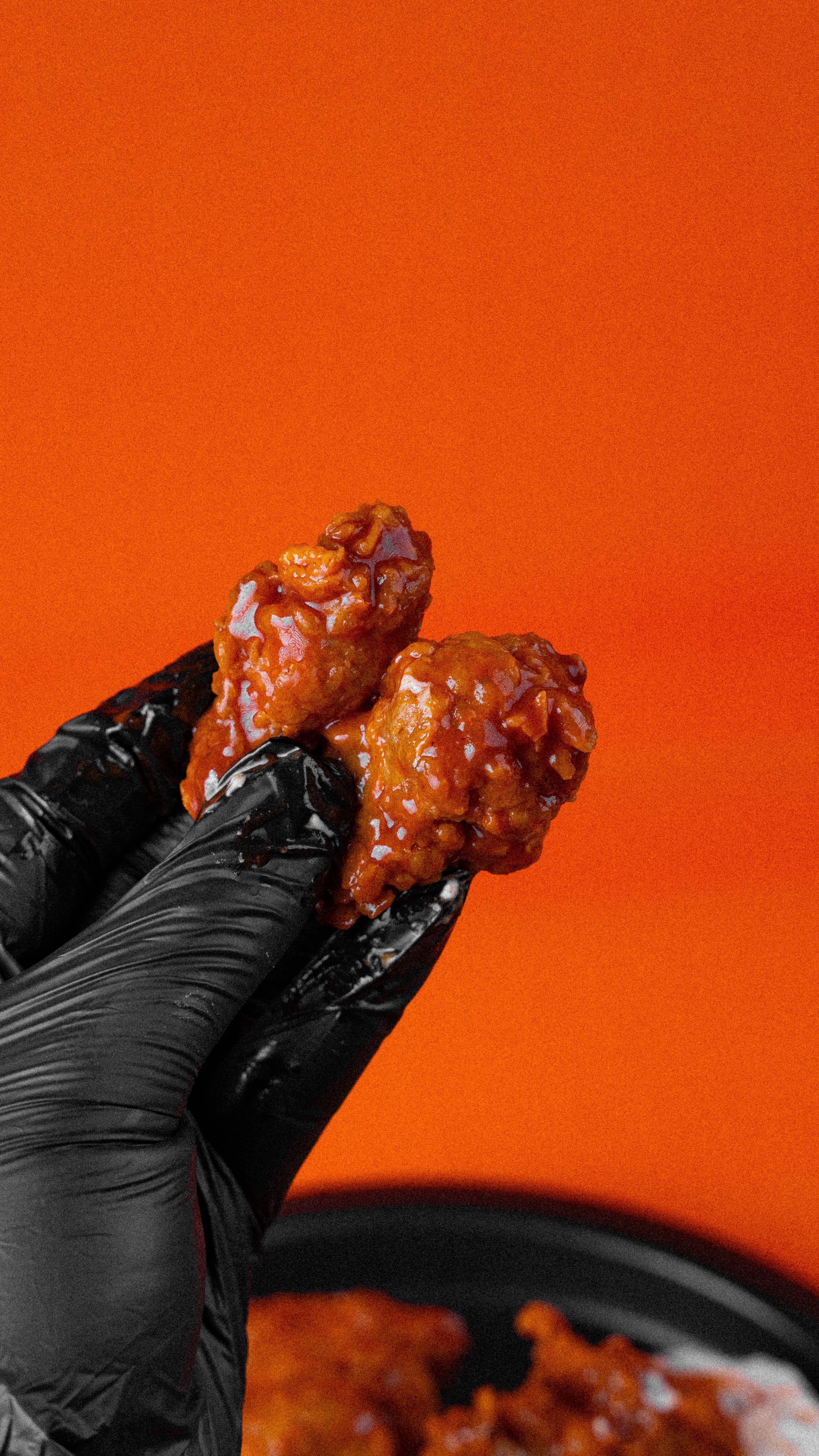 Hand in Black Gloves Holding Glazed Chicken Piece · Free Stock Photo