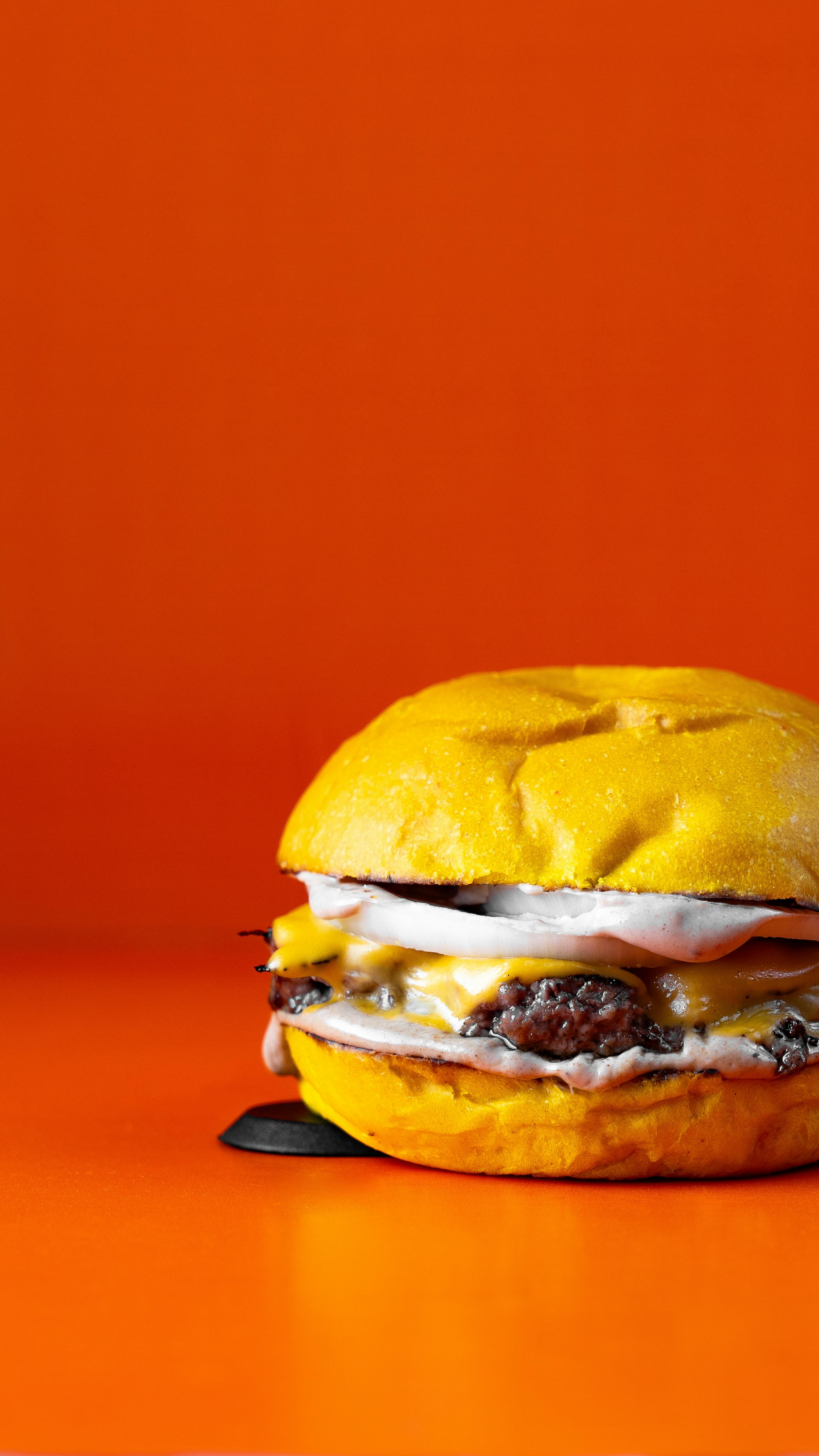 Cheeseburger on Orange Ba · Free Stock Photo