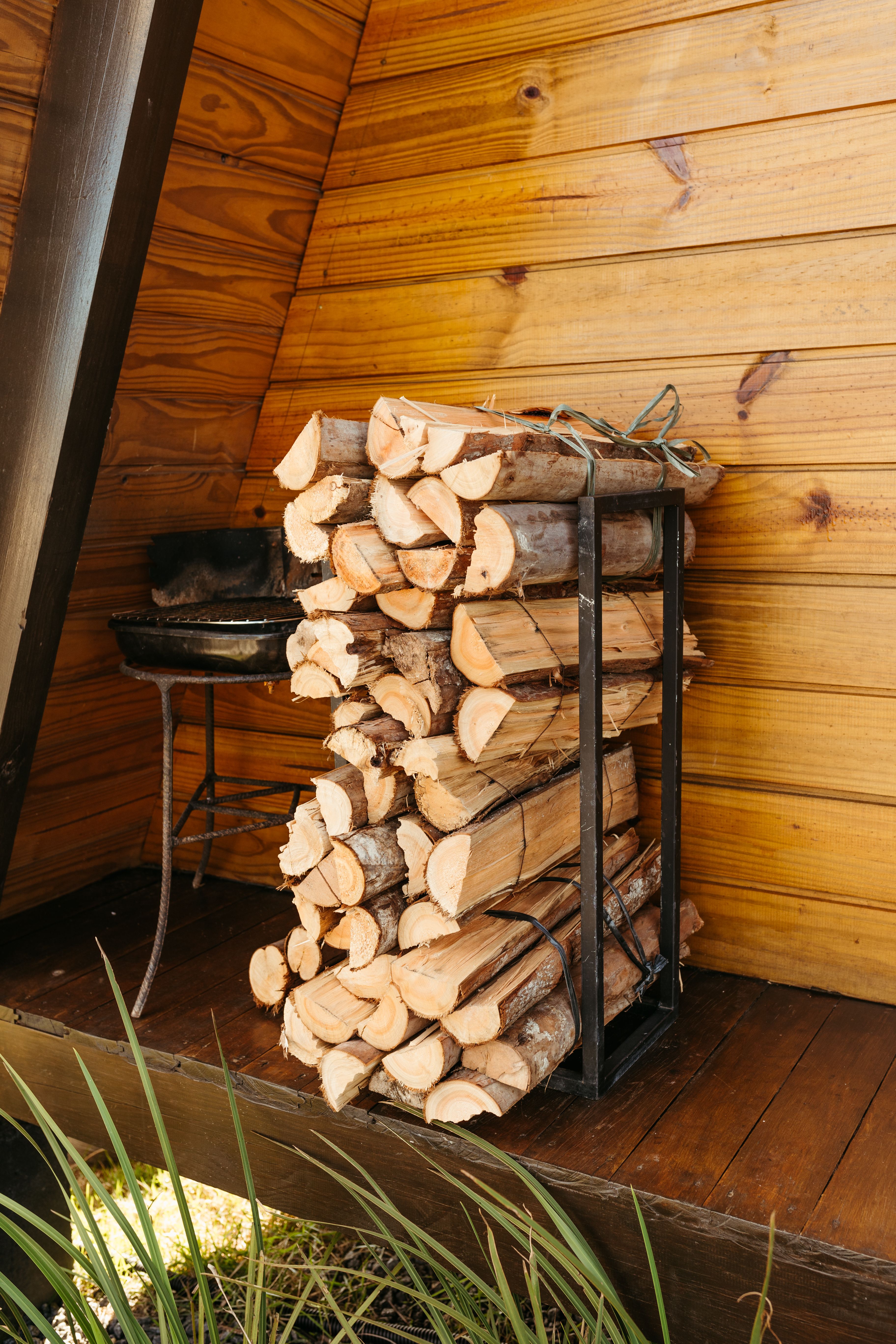 Storage of Firewood by Barbecue at Wooden Cabin · Free Stock Photo