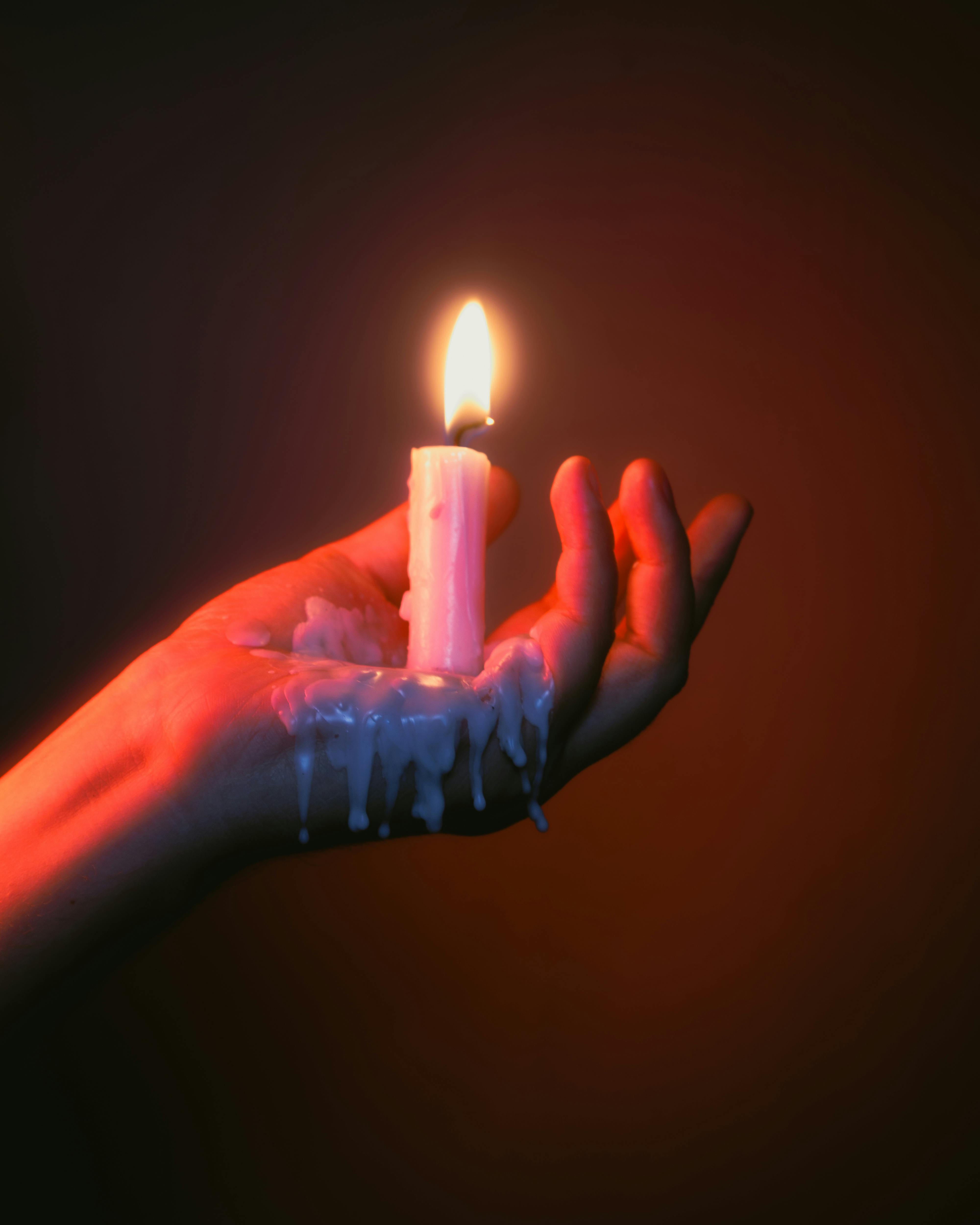Melting Wax Candle in Hand · Free Stock Photo