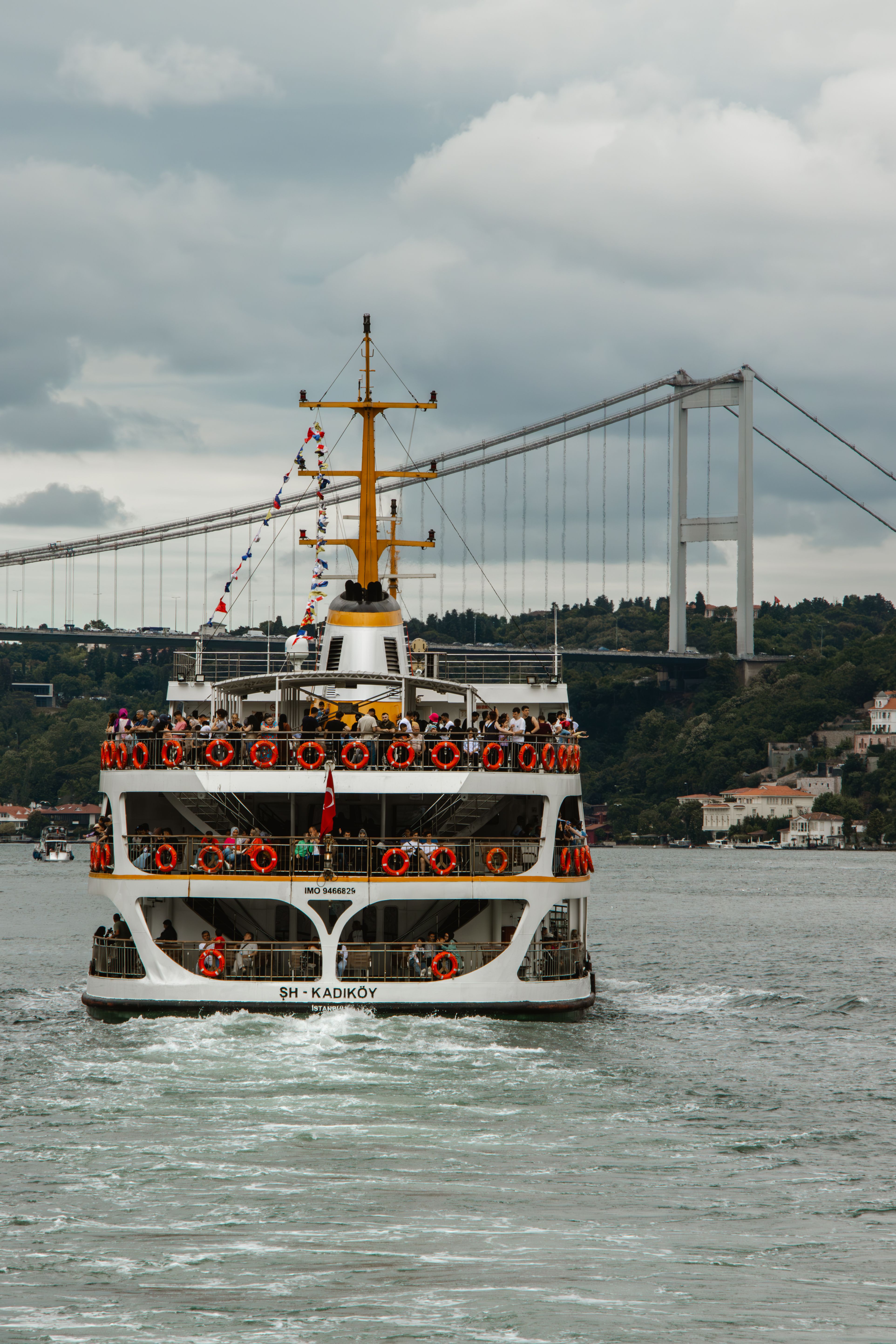 Photo of a Ferry with a View of a Suspension Bridge · Free Stock Photo