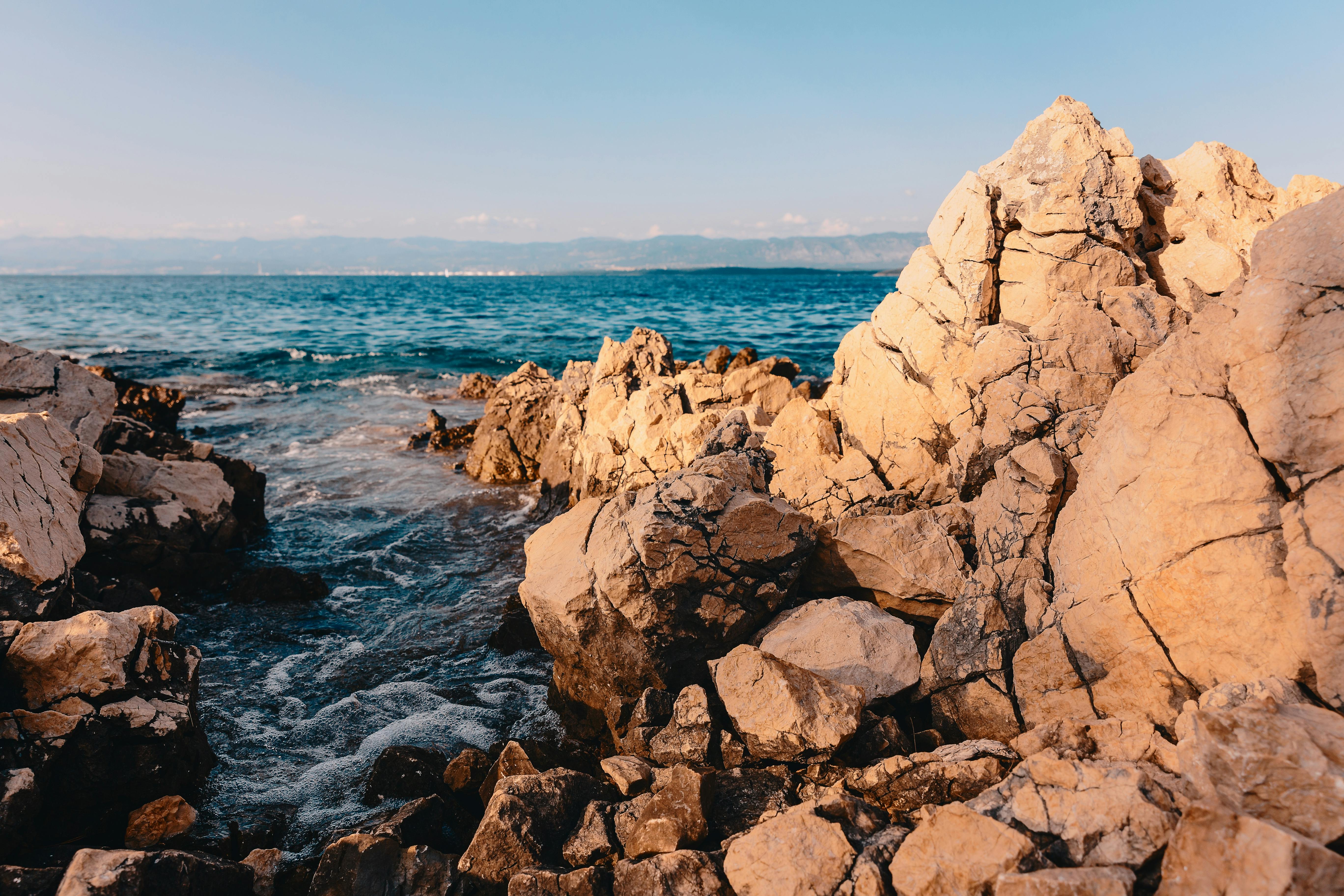 Body of Water and Rock Formation · Free Stock Photo