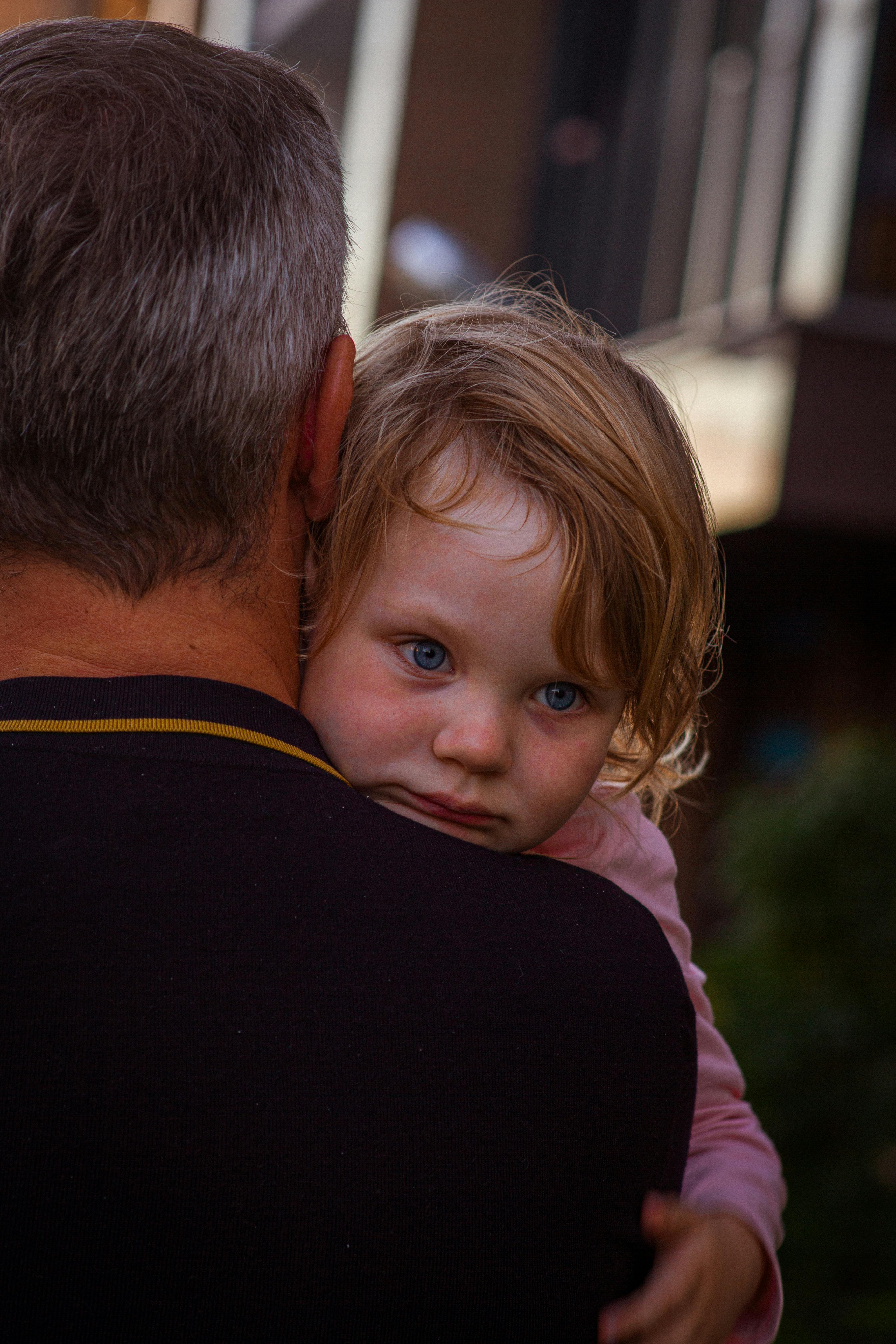 Man Holding a Child in his Arms · Free Stock Photo