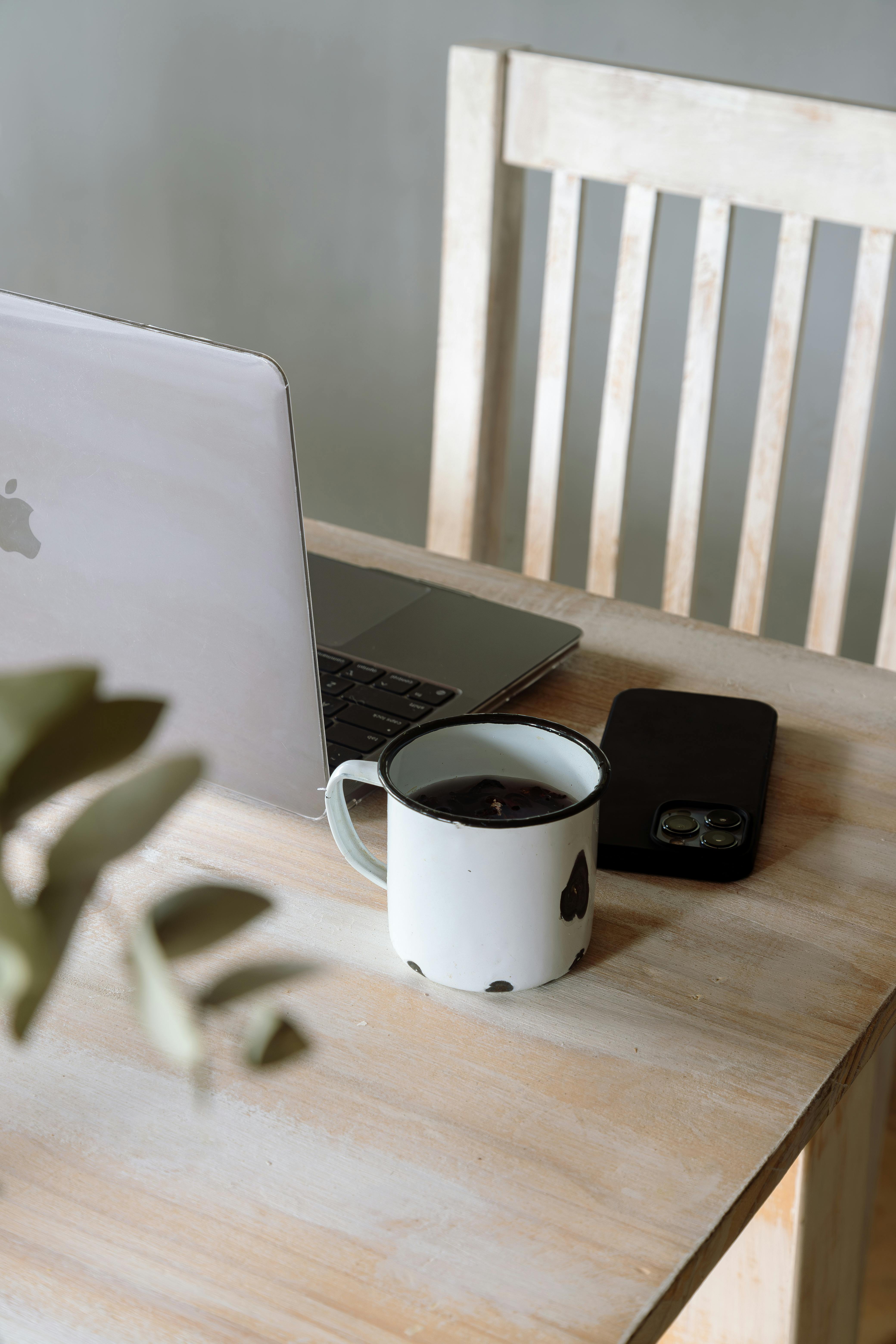 Silver Iphone on Brown Wooden Rack on Top of Table · Free Stock Photo
