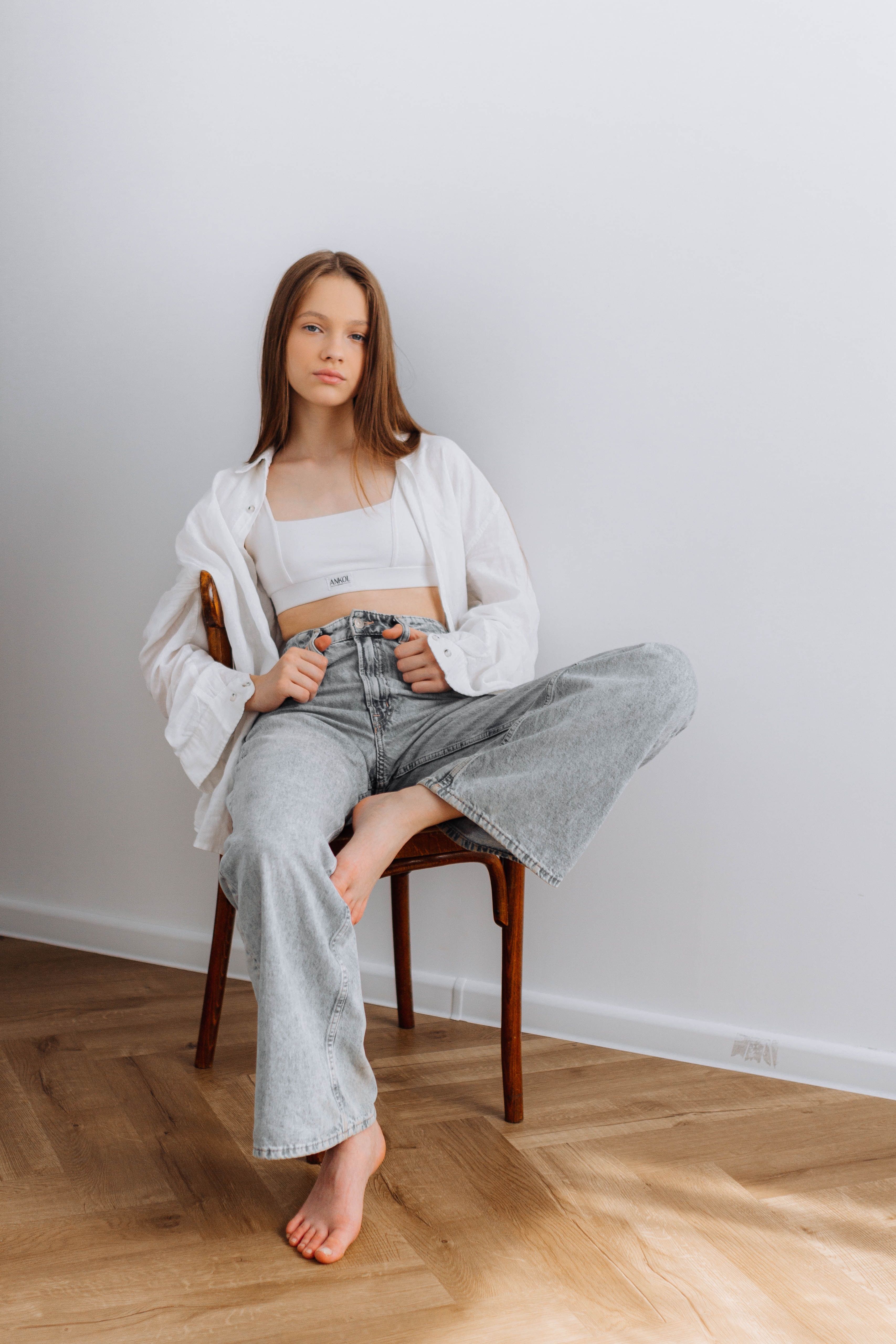 A Barefoot Teenage Girl Sitting on a Chair · Free Stock Photo