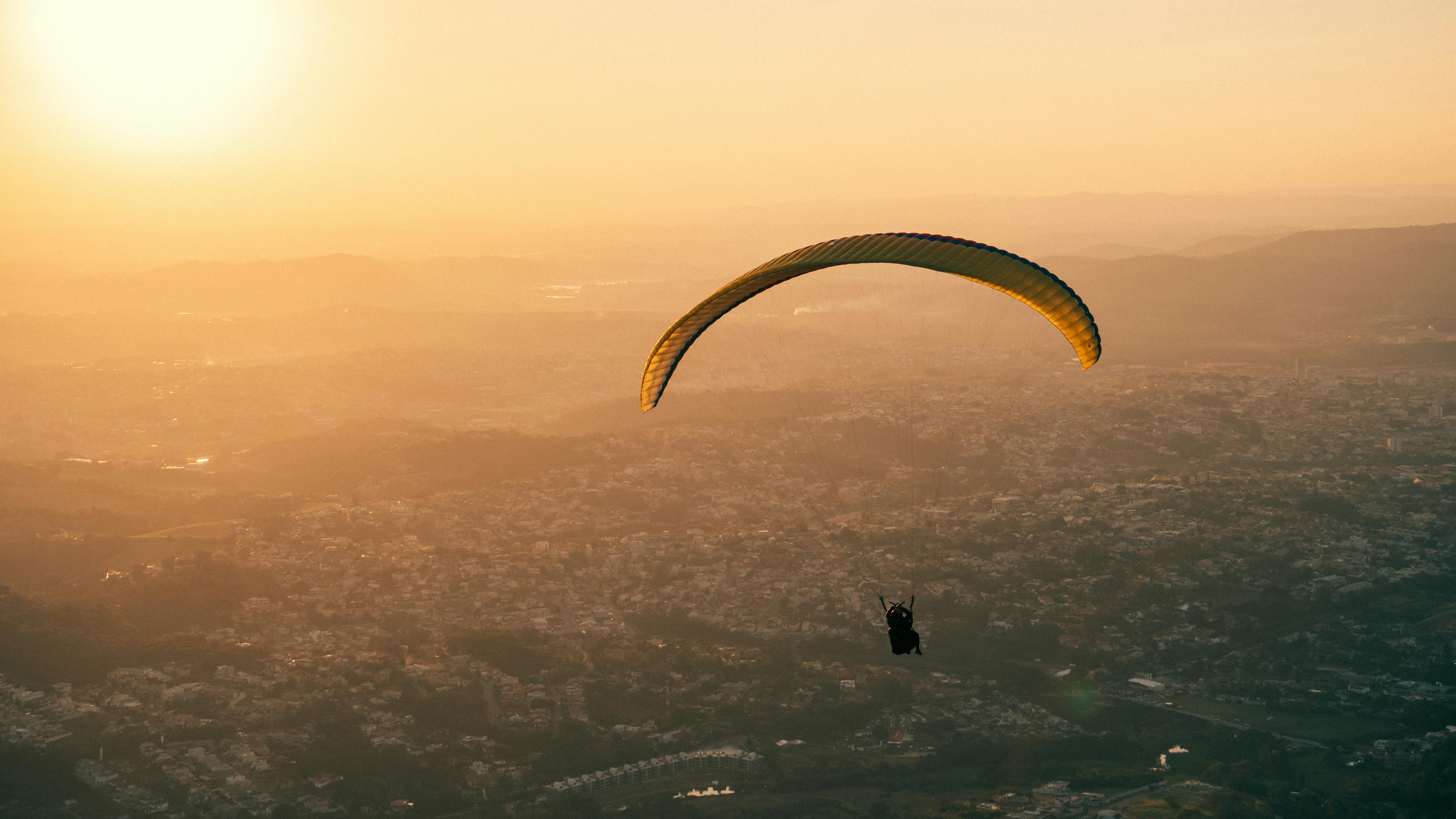 Parachuting over City at Sunset · Free Stock Photo