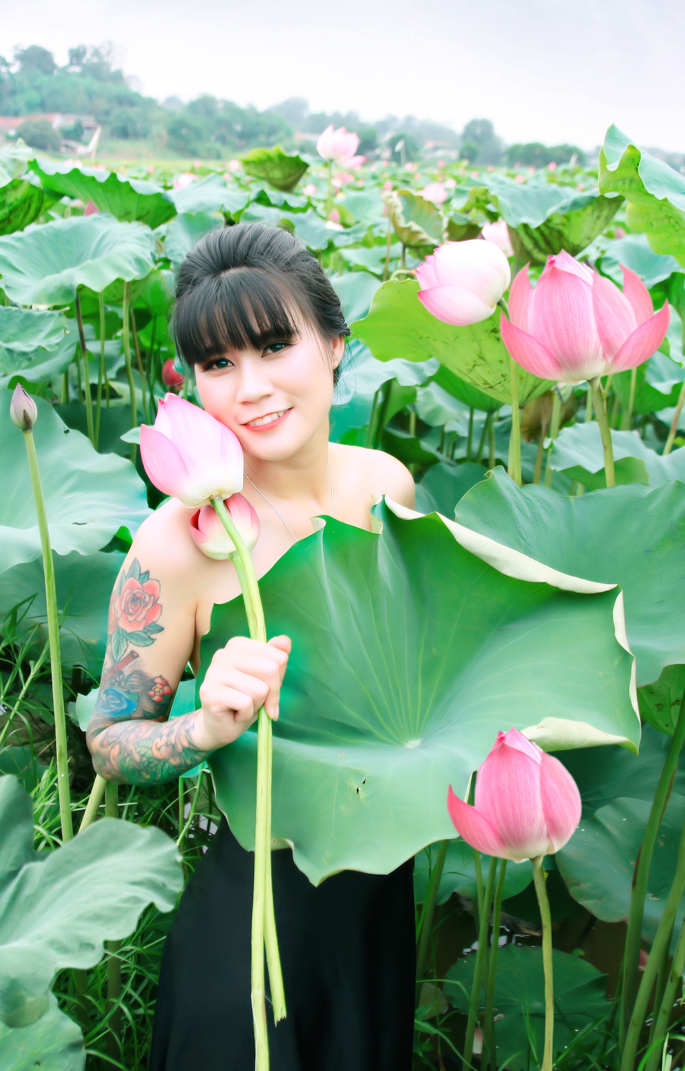 Photo of a Woman with a Lotus Flower · Free Stock Photo