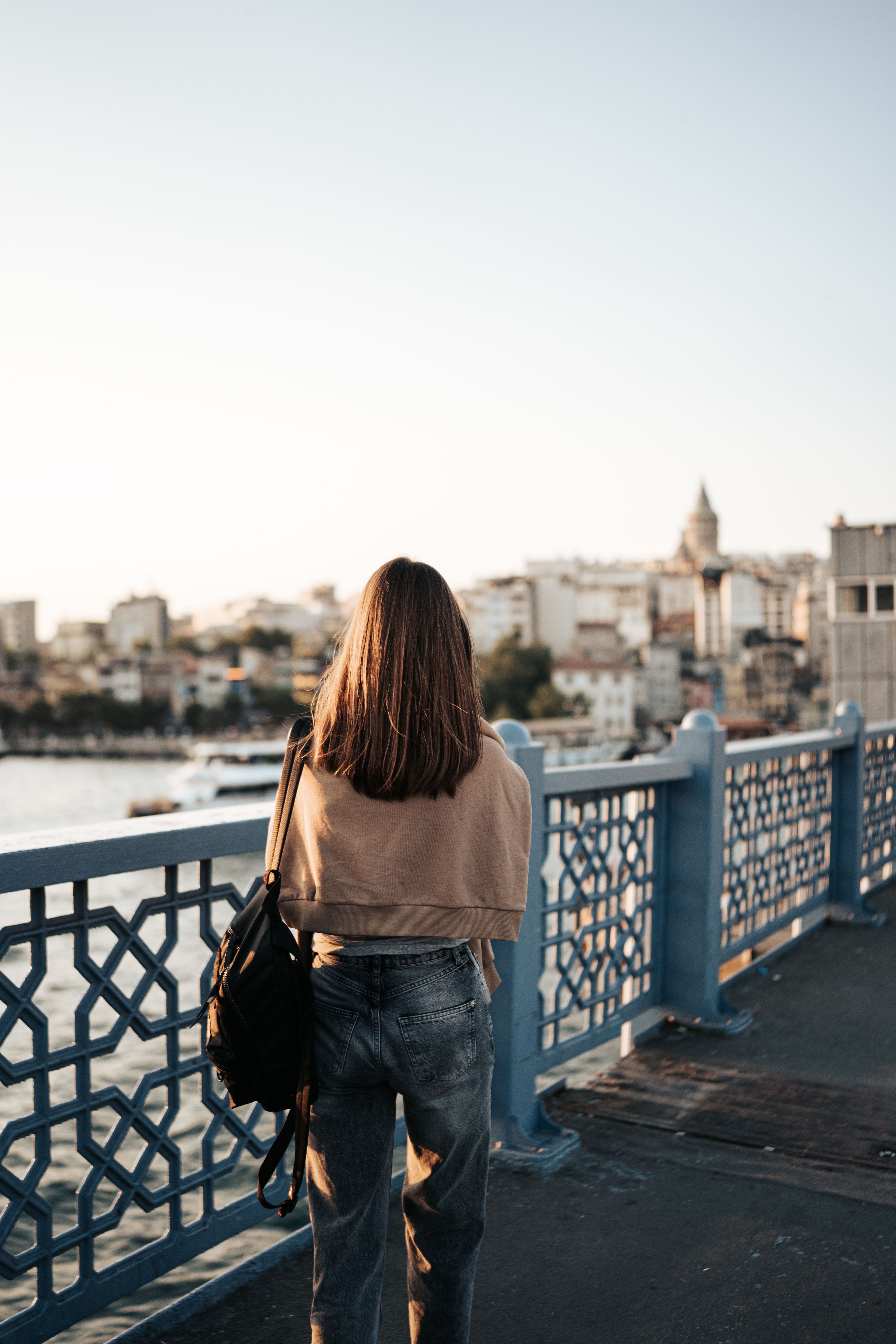Woman Standing on Bridge Taking Waterfront Photo of Istanbul · Free ...