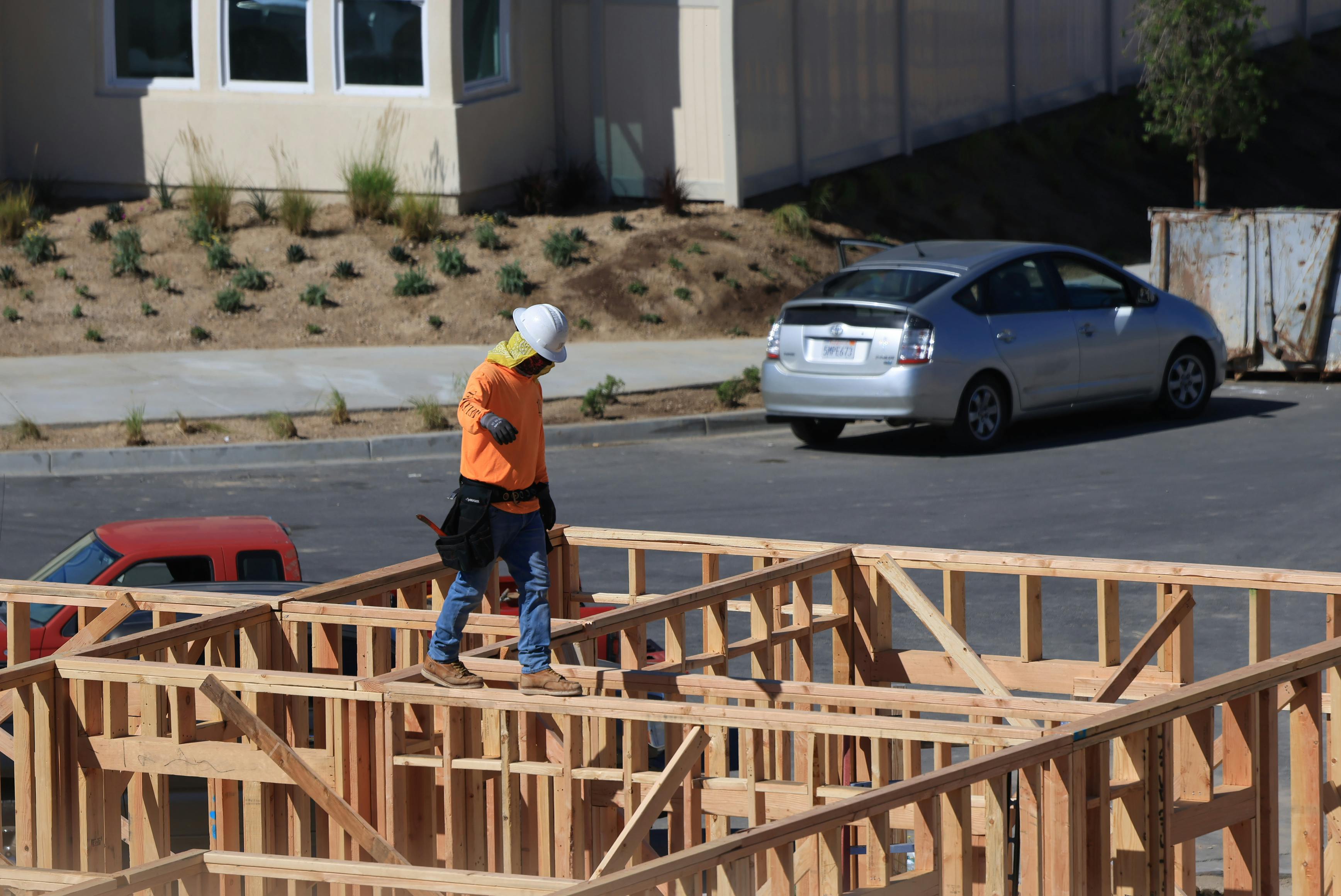 Worker Walking on House Construction · Free Stock Photo