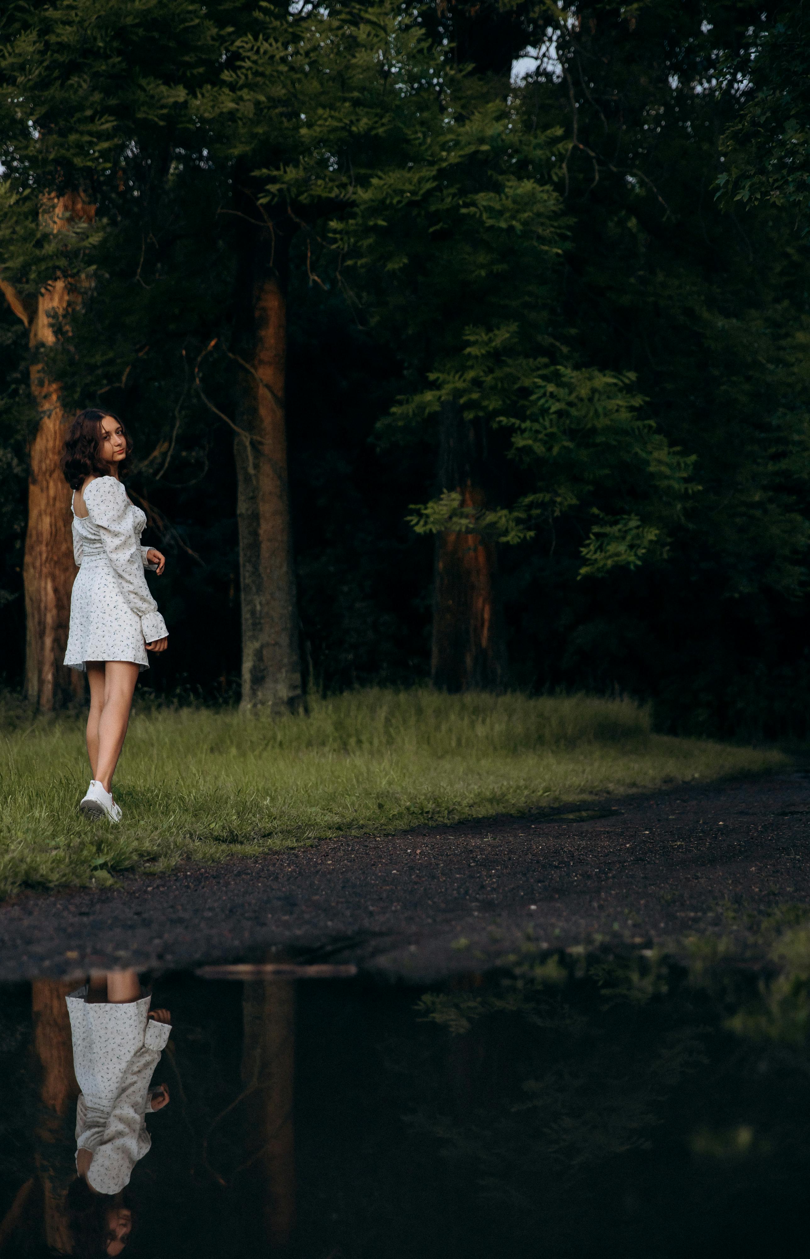 Women in Traditional Clothes Walking on the Street with Water Puddle · Free Stock Photo