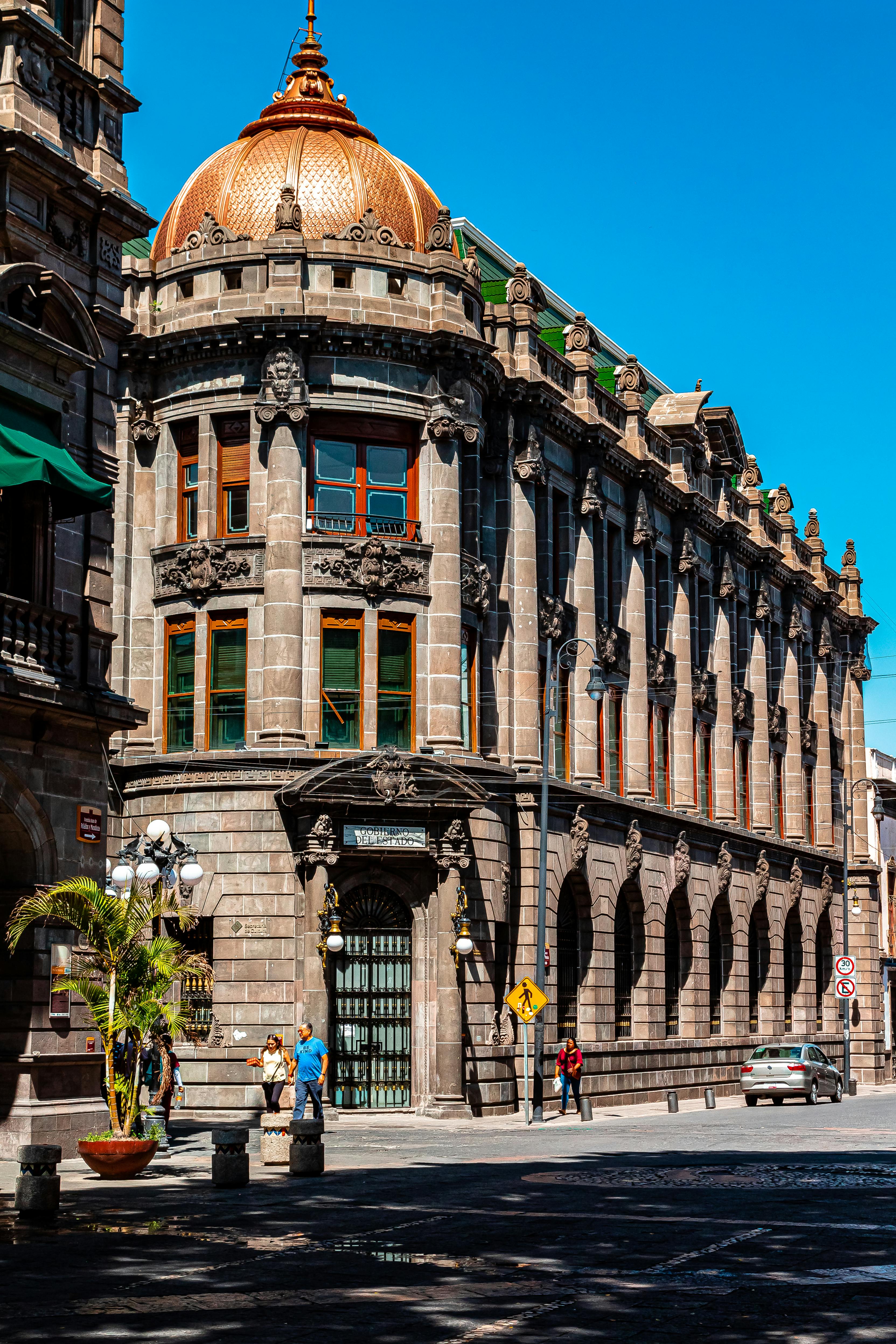 Ornamented Building by Street in Town · Free Stock Photo