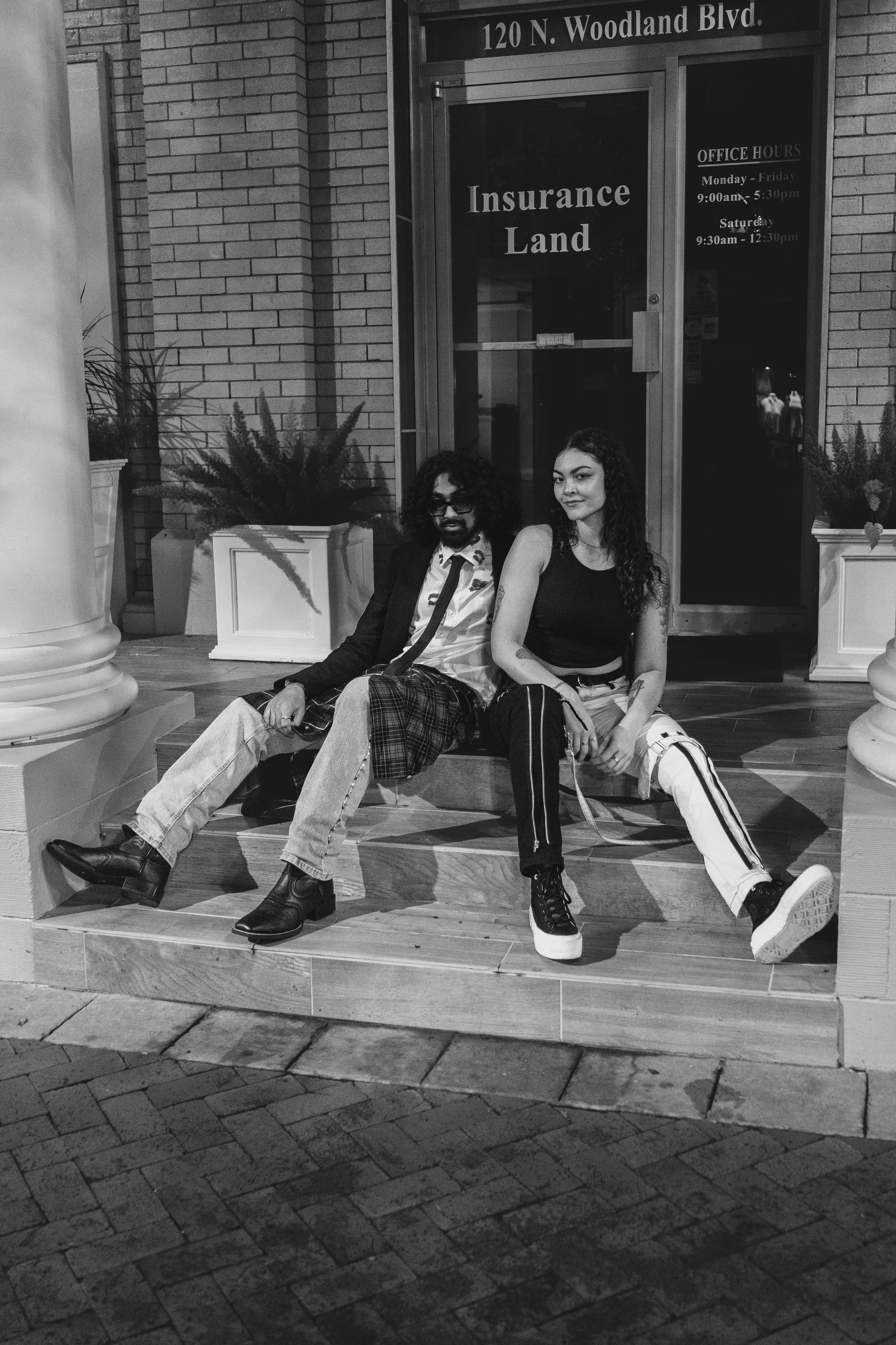Black and White Photo of a Stylish Young Couple Sitting on Steps · Free ...