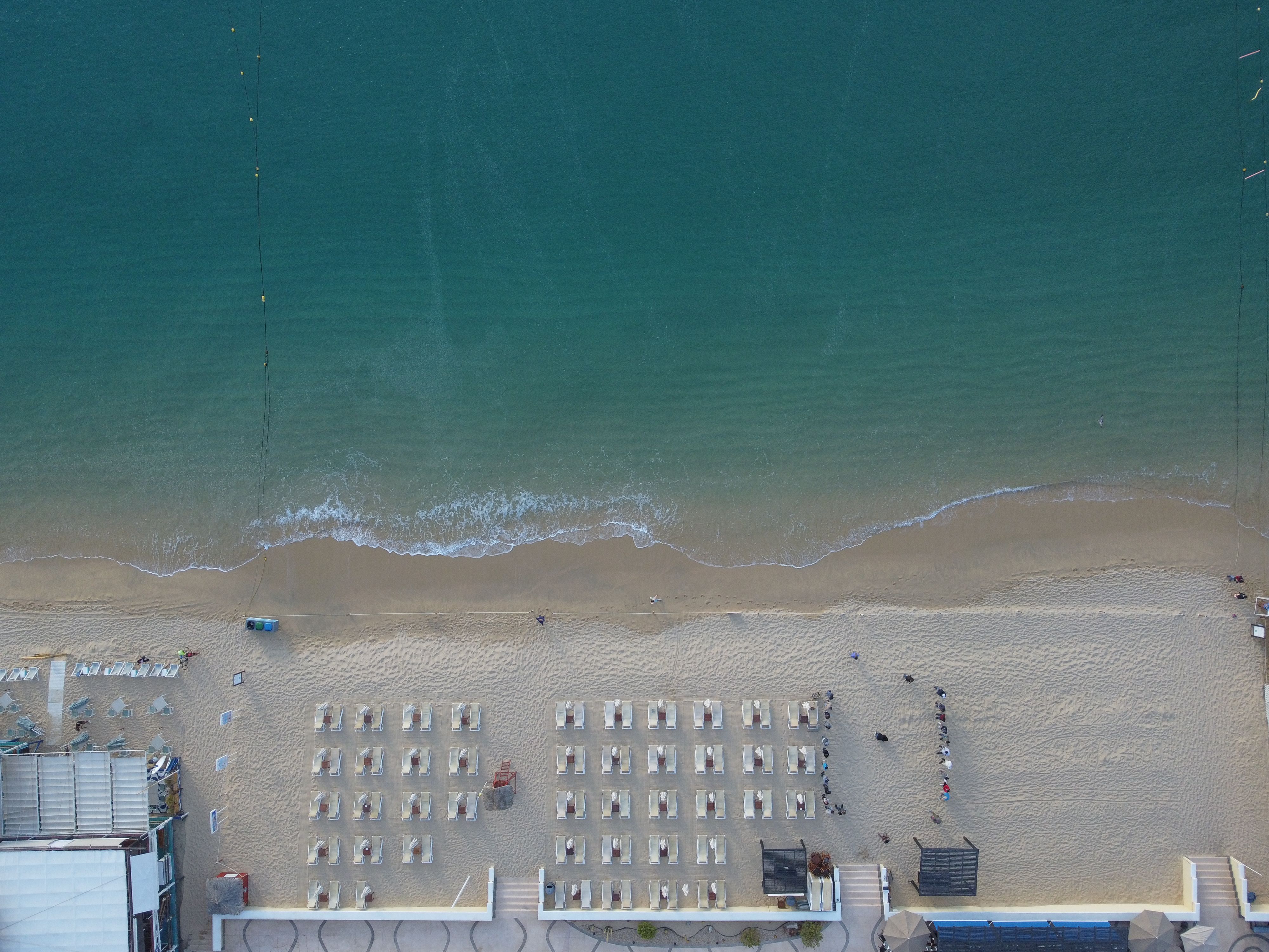 Top View of Empty Sun Loungers on a Beach · Free Stock Photo