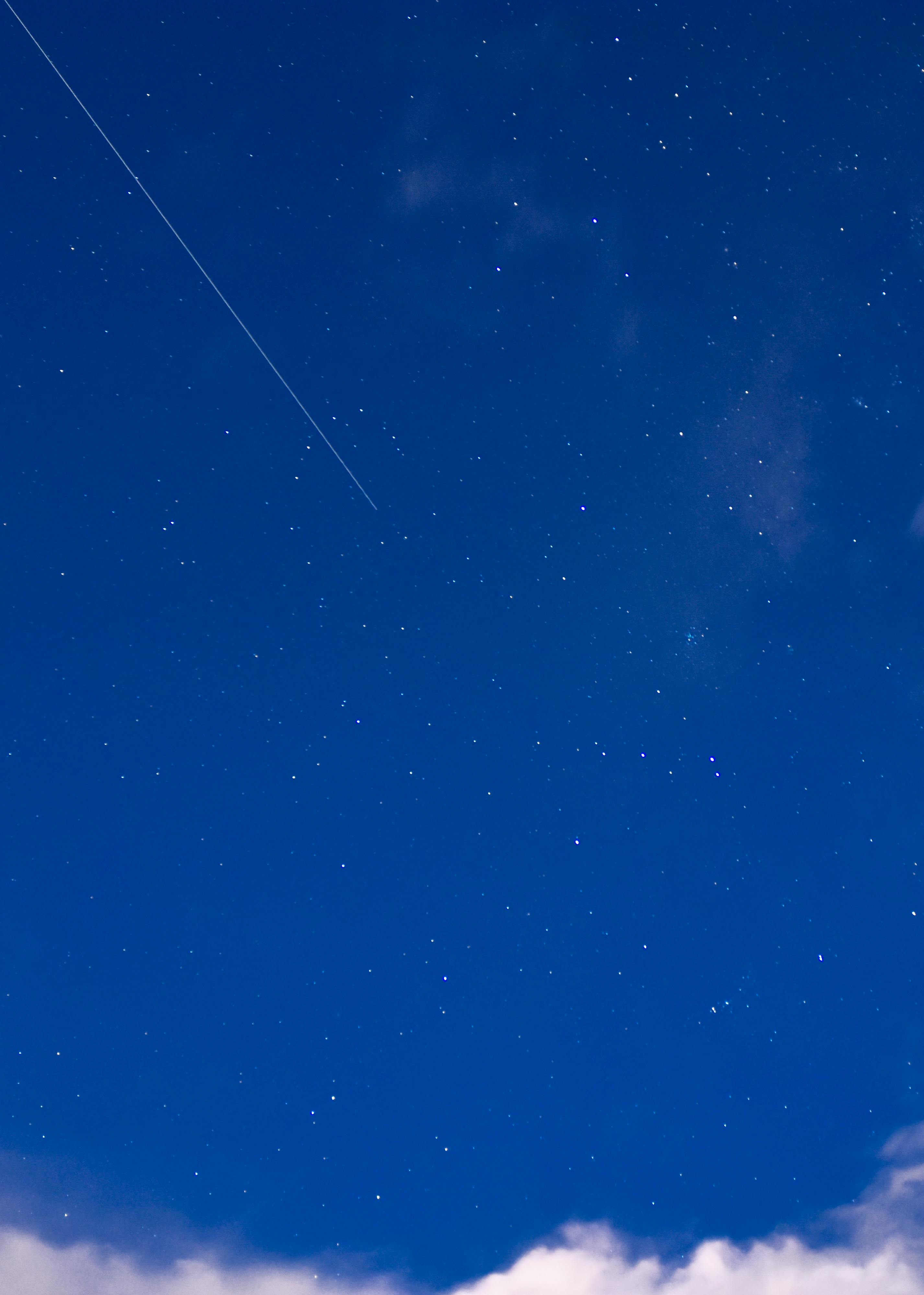 Silhouette of Person Standing on Rock Under Blue Sky during Night Time ...