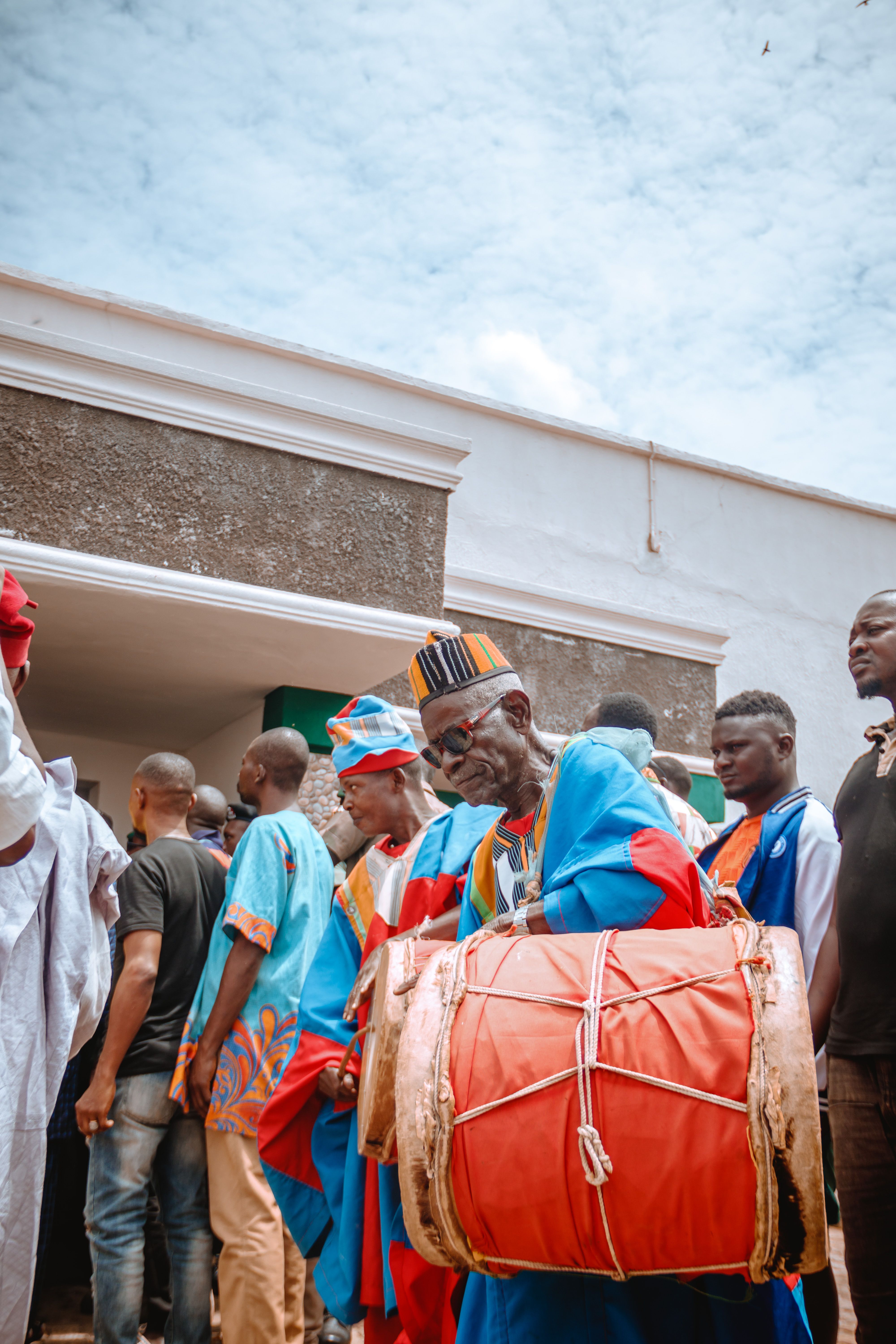 Drummer in Traditional Clothing Among Crowd · Free Stock Photo