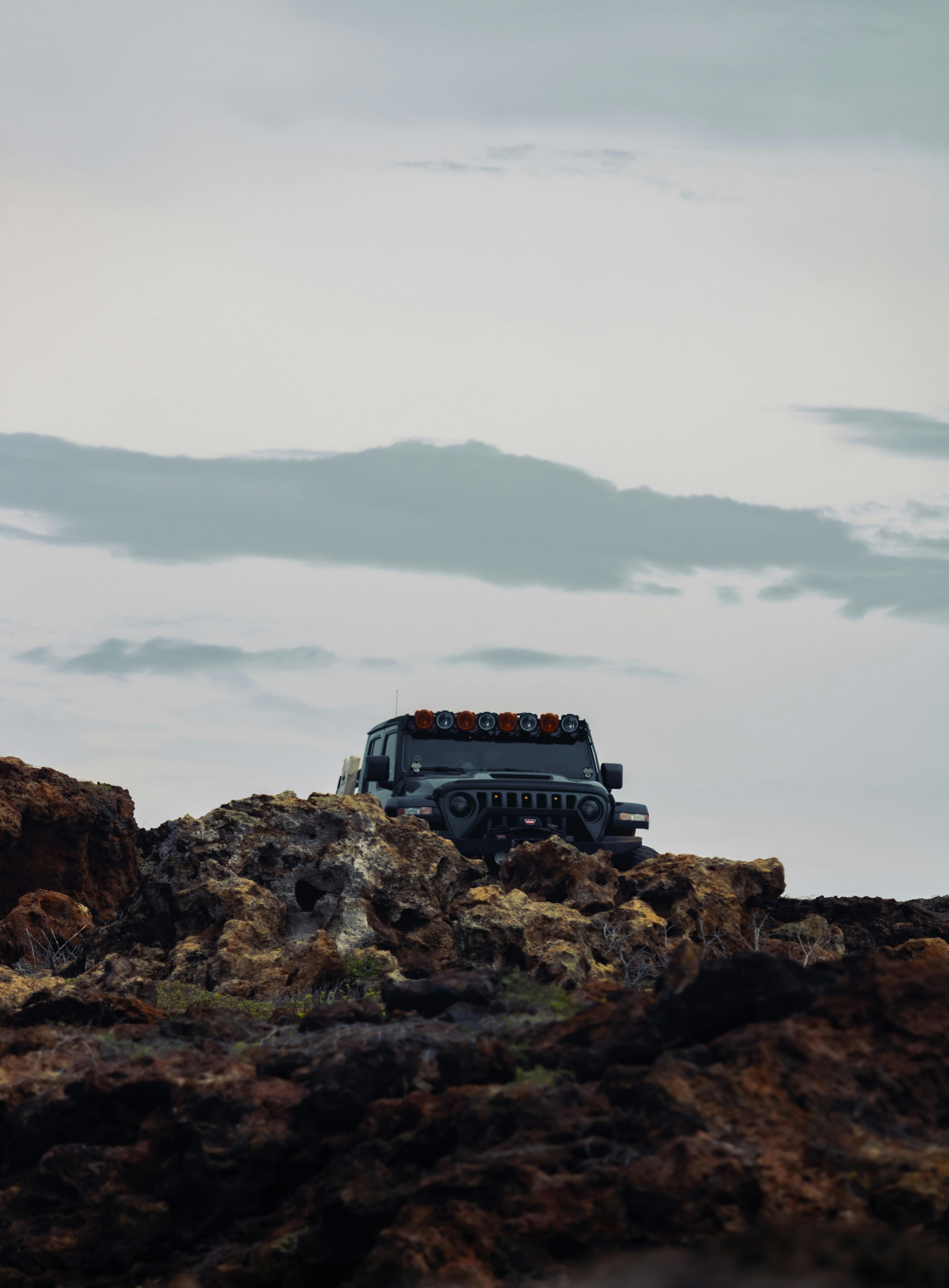 Jeep Wrangler behind Rocks · Free Stock Photo