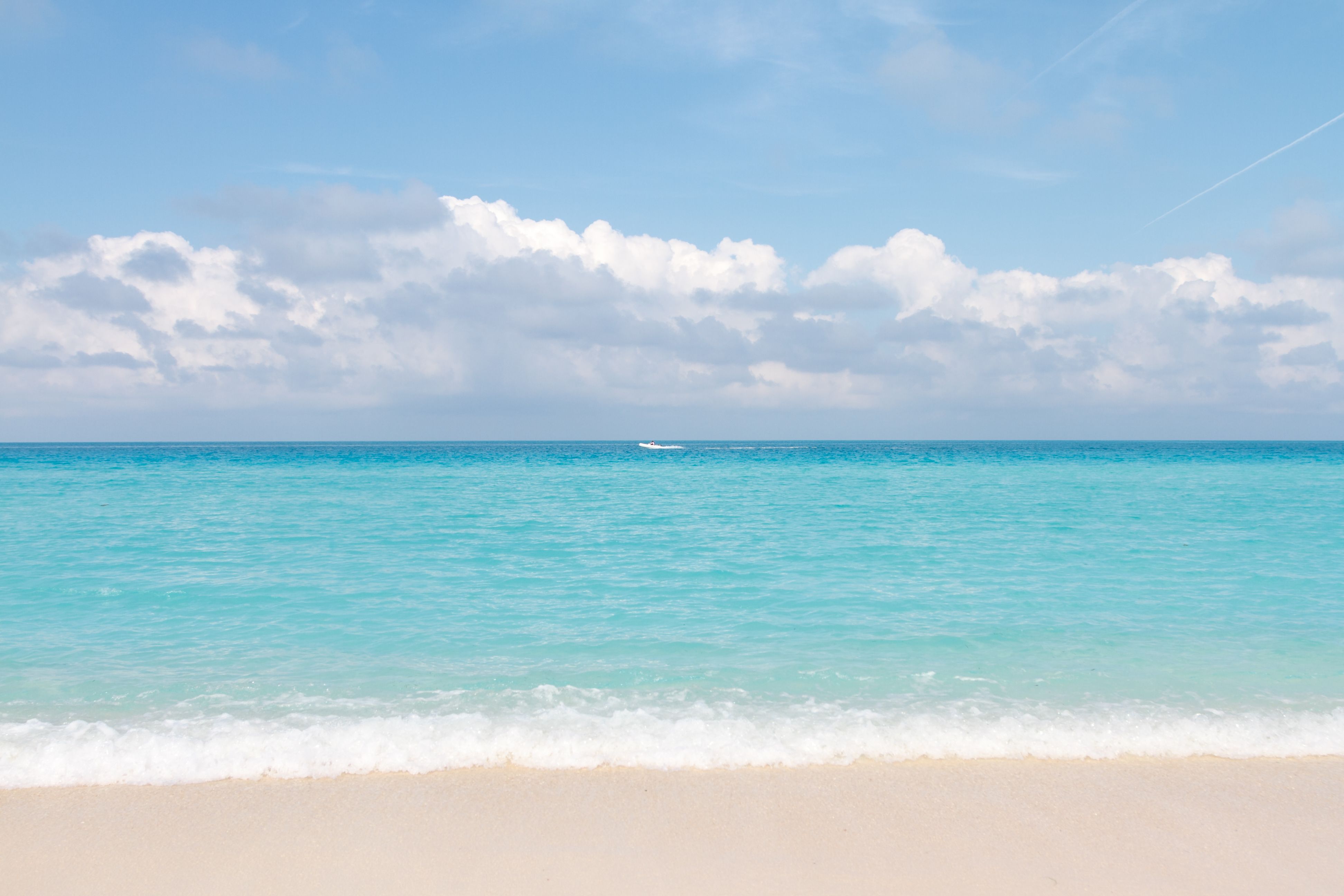 Sunlit Motorboat on Beach · Free Stock Photo