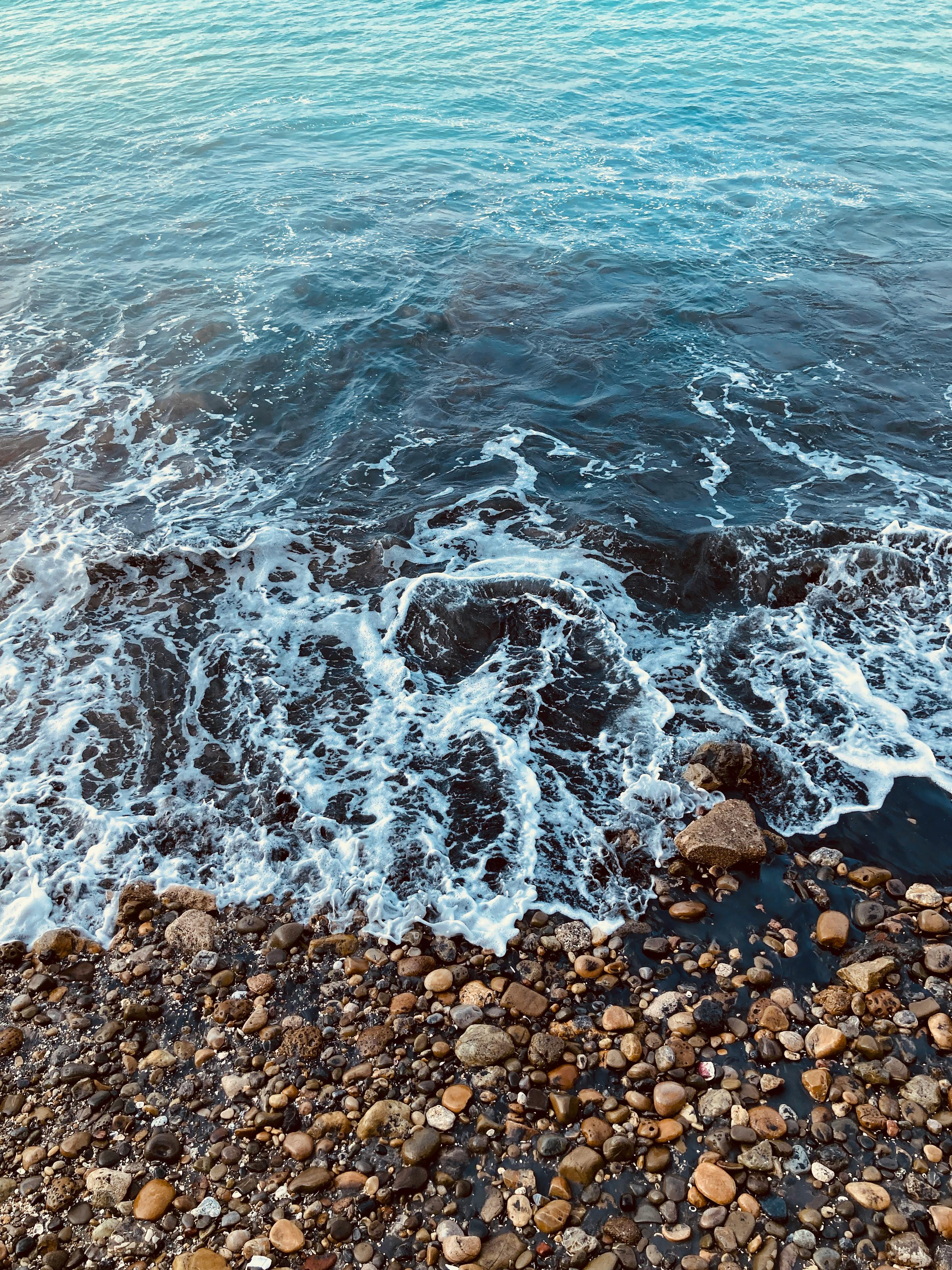 Brown Rock Formation on Body of Water at Daytime · Free Stock Photo