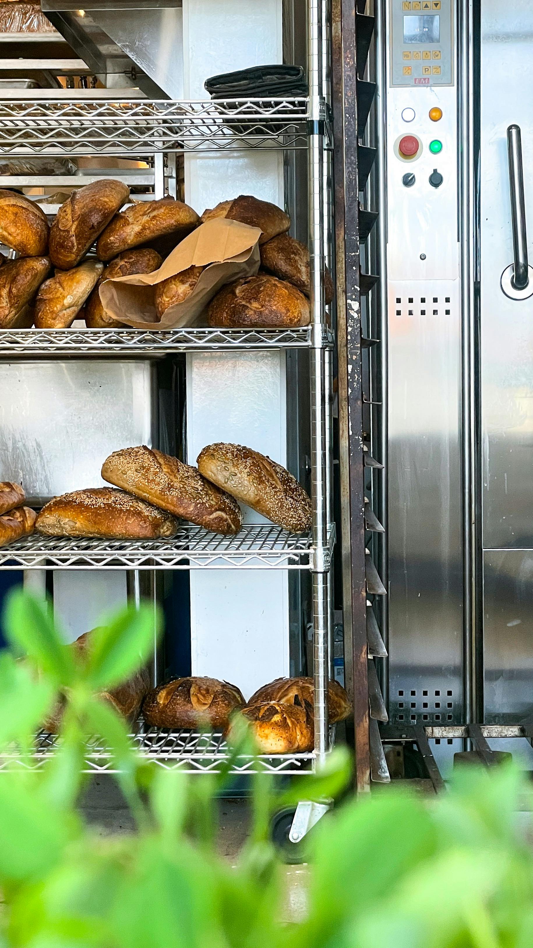 Close-up Photo of Three Baguettes on Brown Wooden Surface With White ...