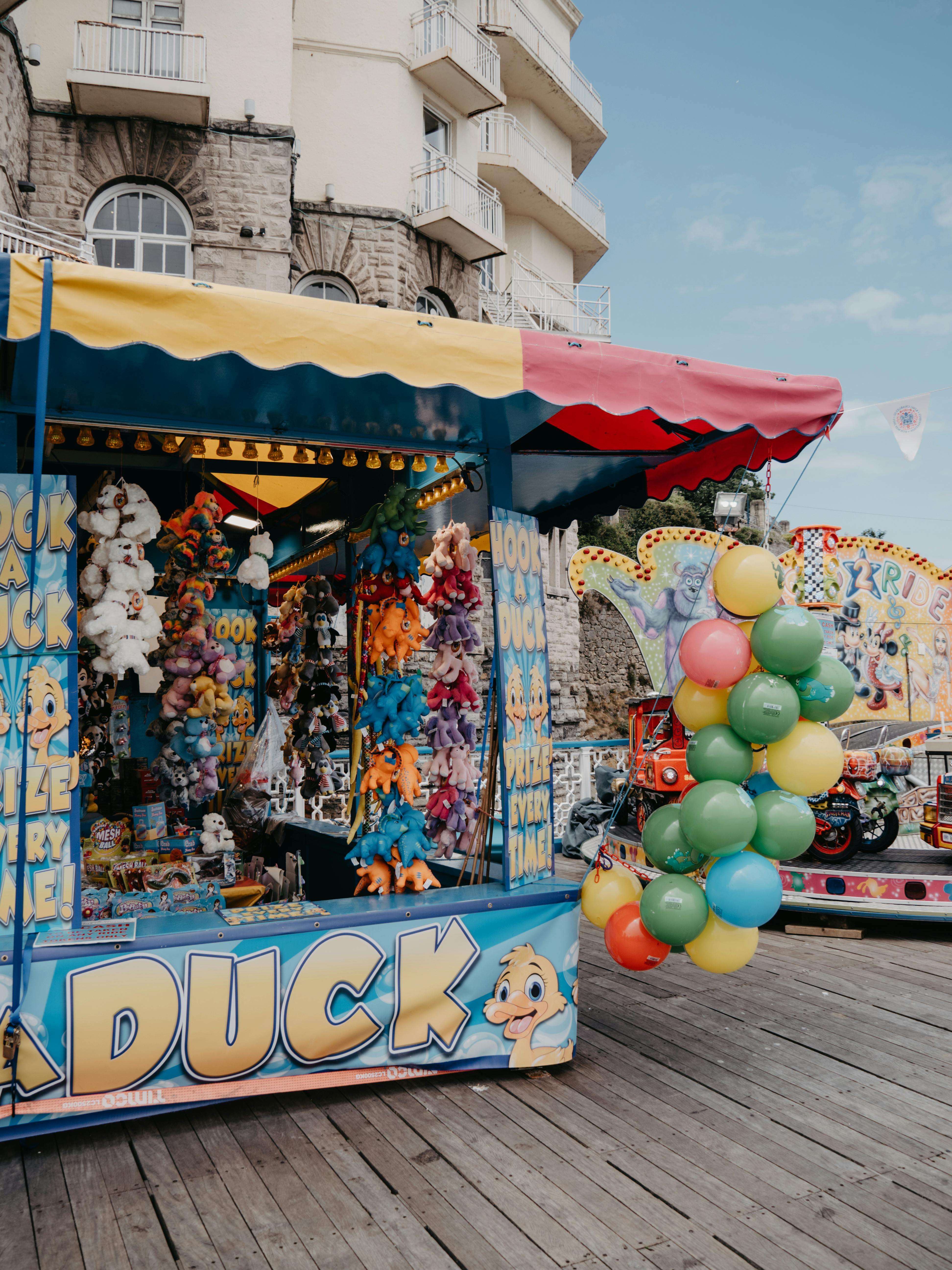Tourist by Funfair Stall with Toys · Free Stock Photo