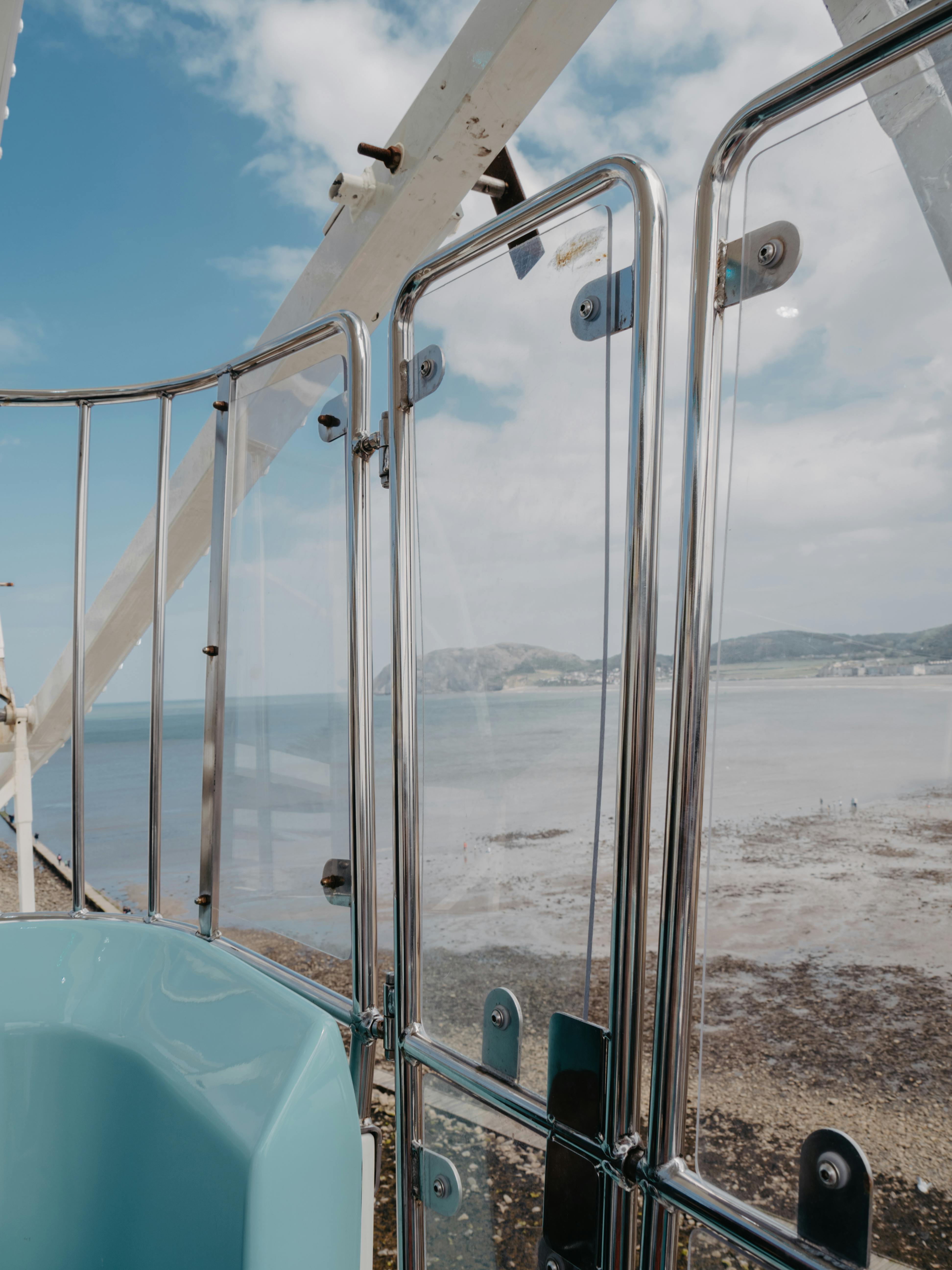 Sea Shore behind Ferris Wheel Windows · Free Stock Photo