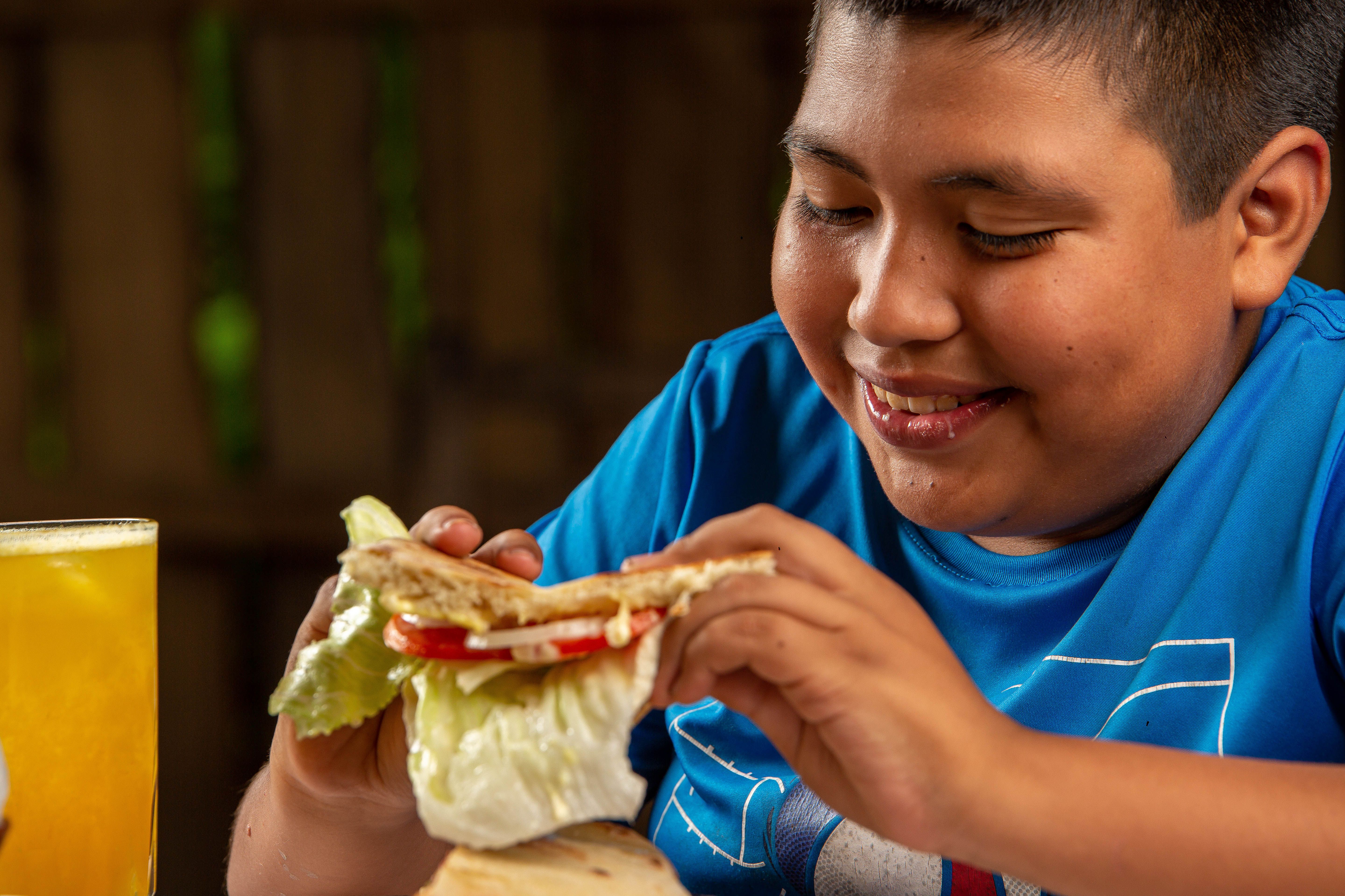Smiling Boy Eating Tortilla · Free Stock Photo