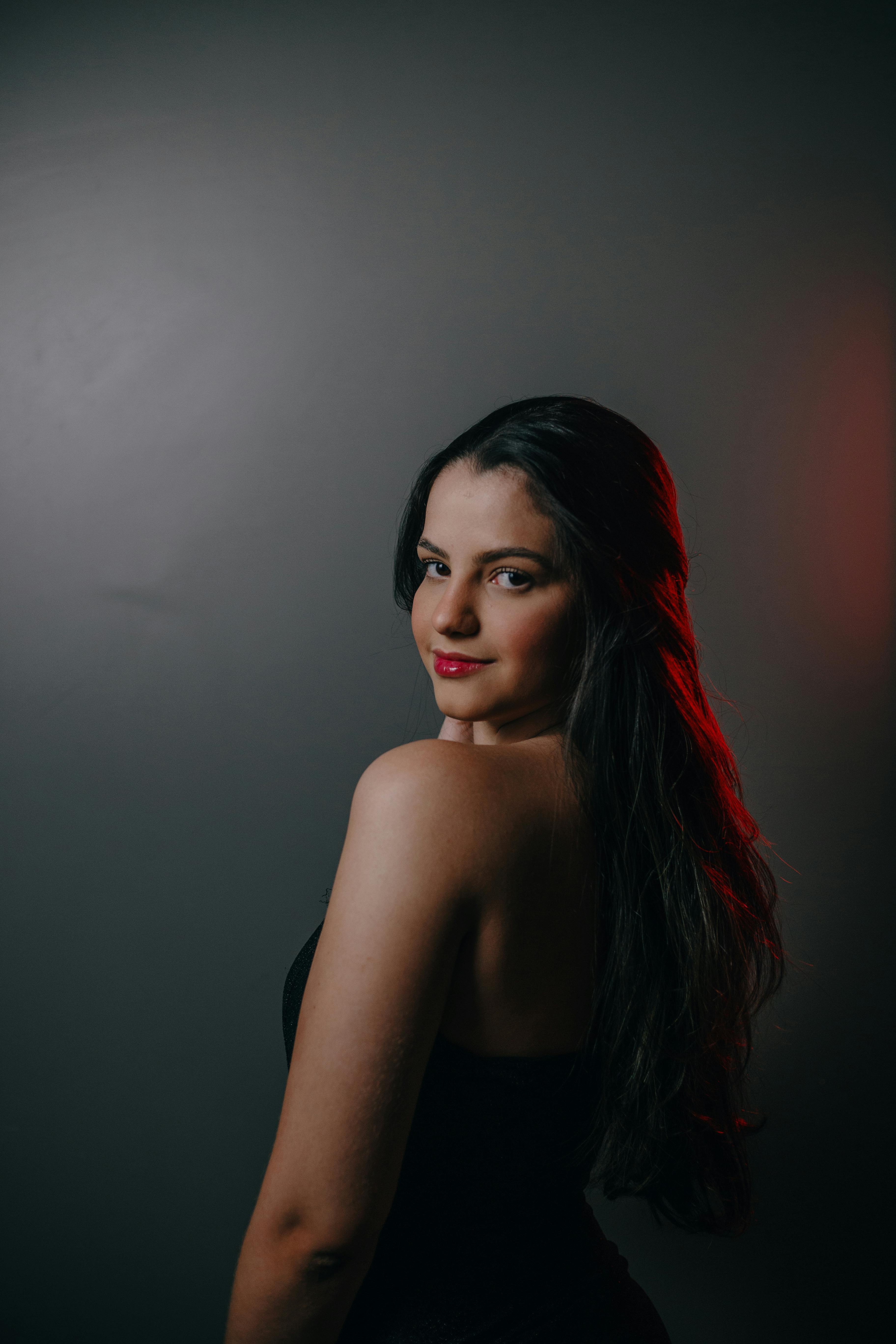 Studio Shot of a Young Elegant Woman Looking over Shoulder · Free Stock ...