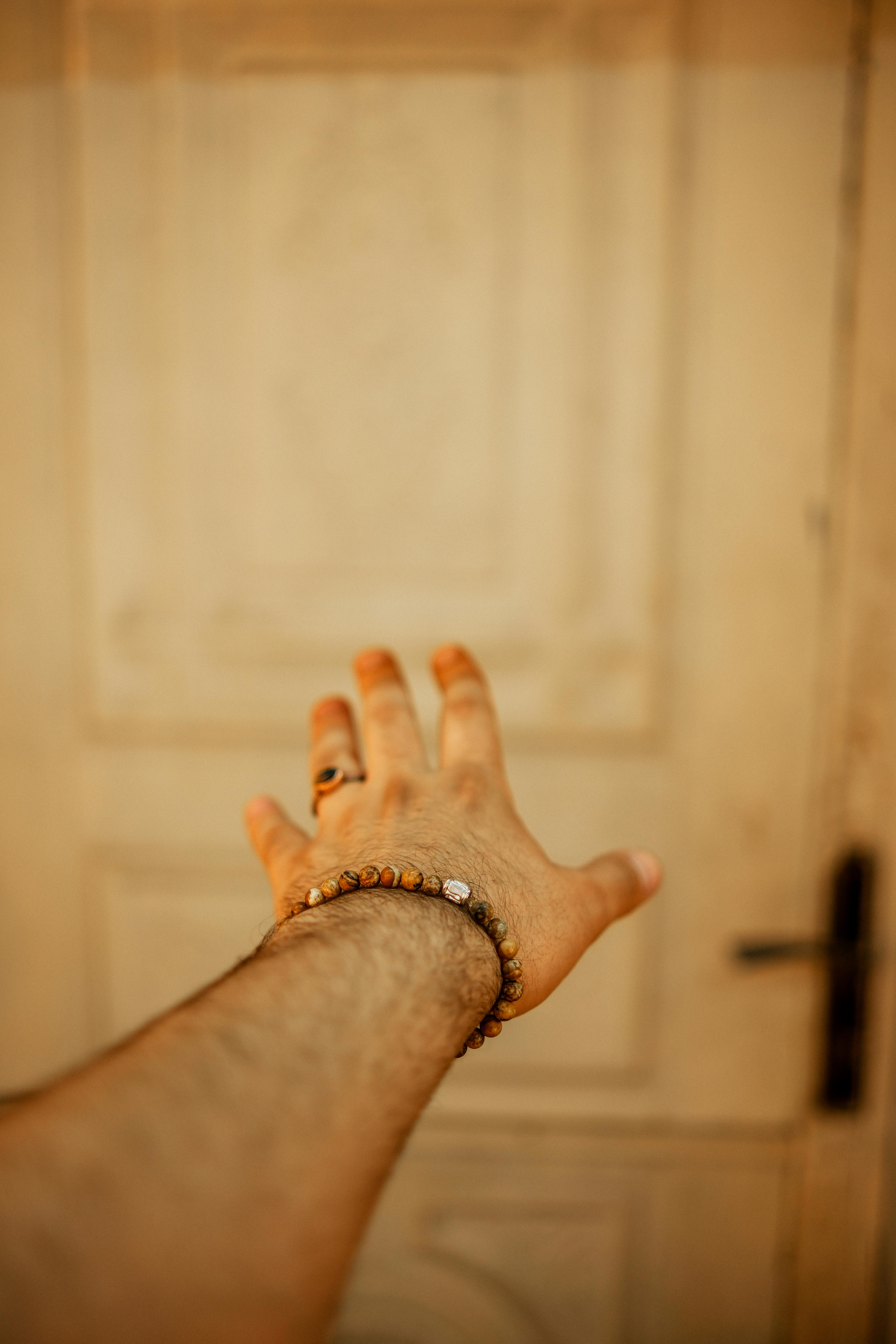Arm of a Man Reaching Toward the Door · Free Stock Photo