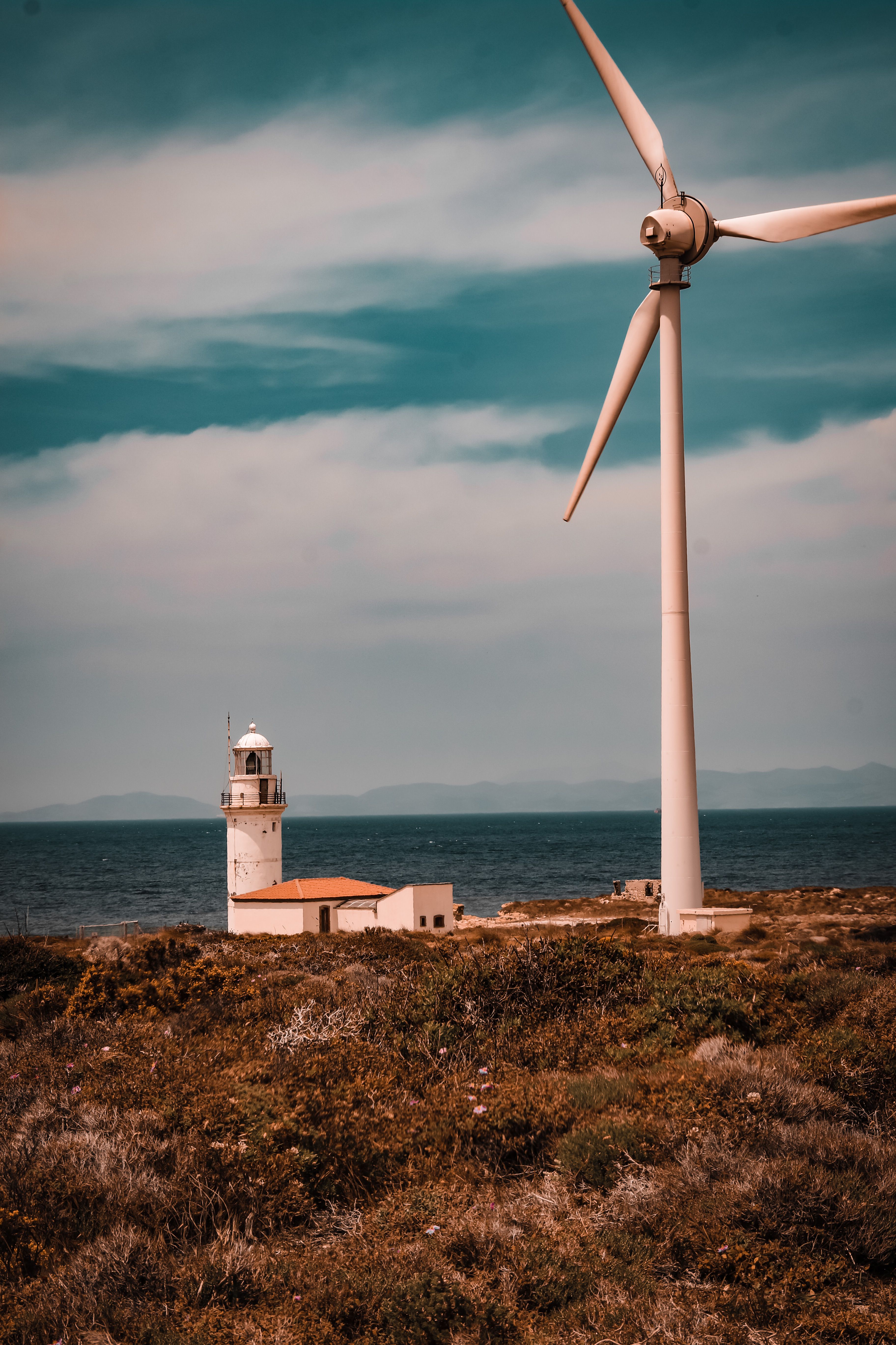 Wind Turbine near Lighthouse on Sea Coast · Free Stock Photo