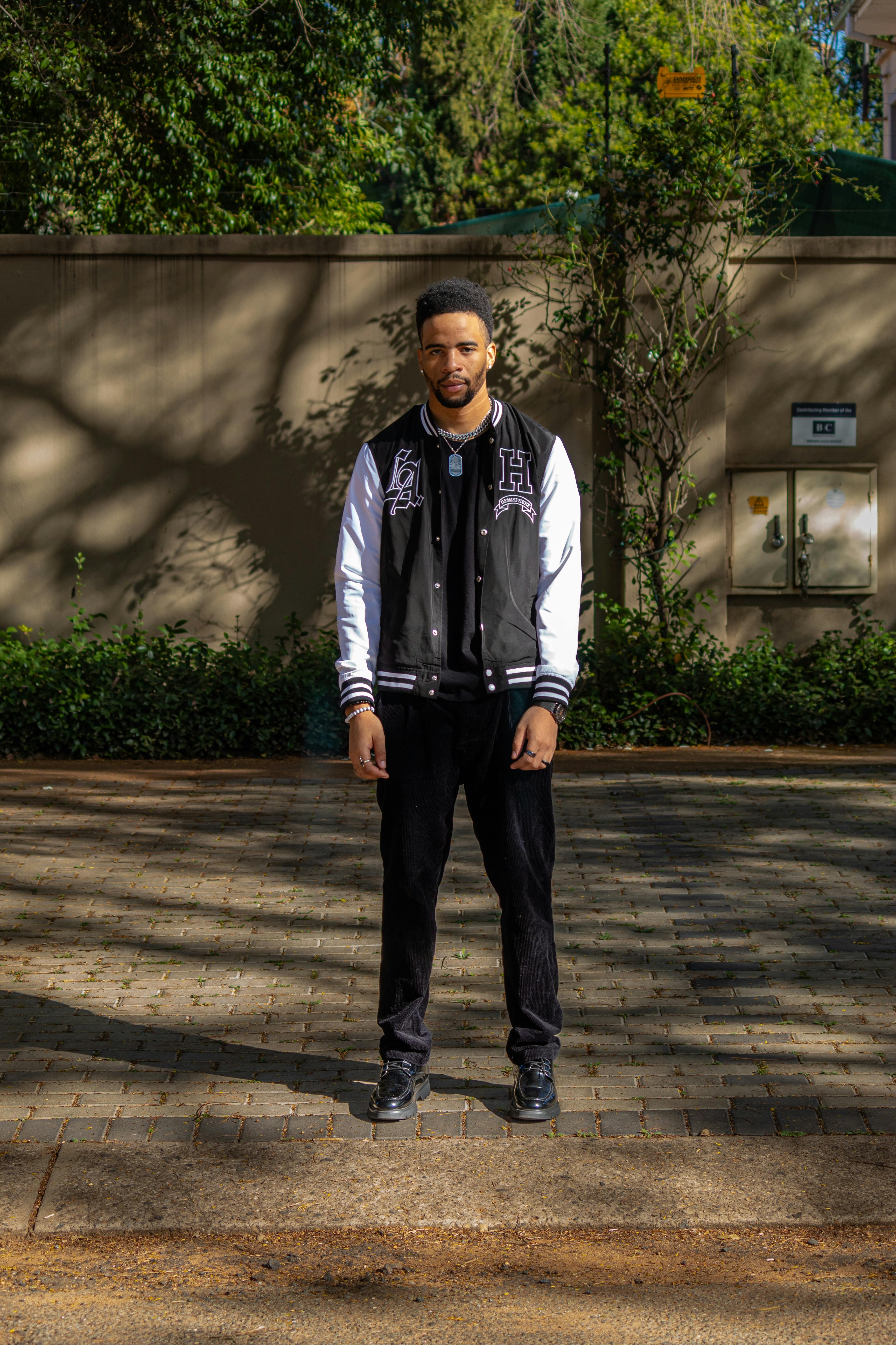 Young Man Standing on the Sidewalk · Free Stock Photo
