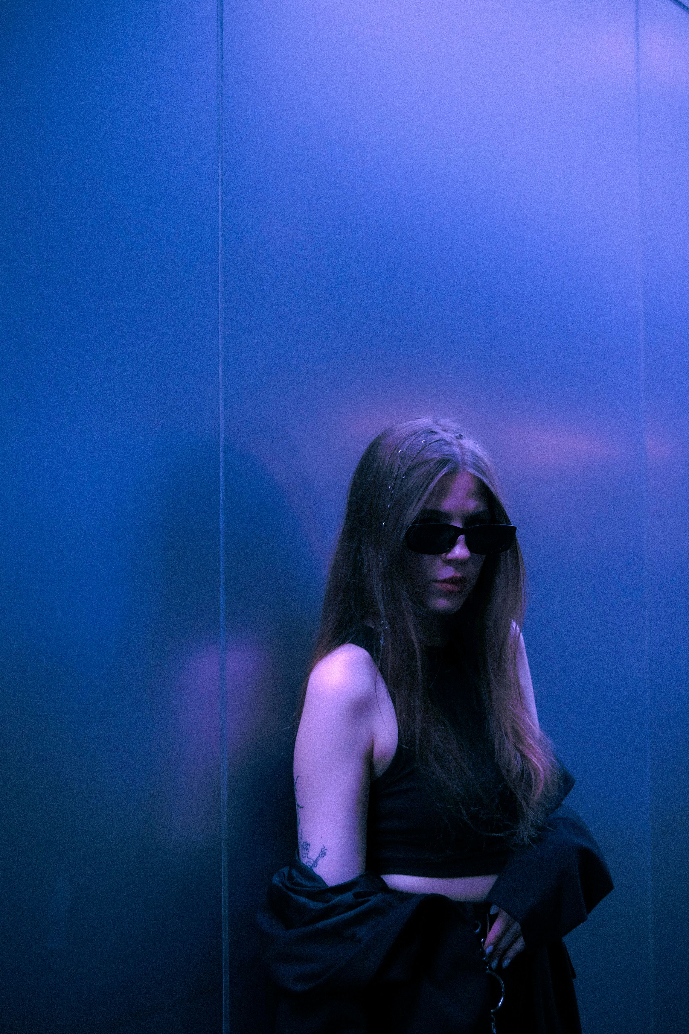 Girl Posing against Blue Background · Free Stock Photo